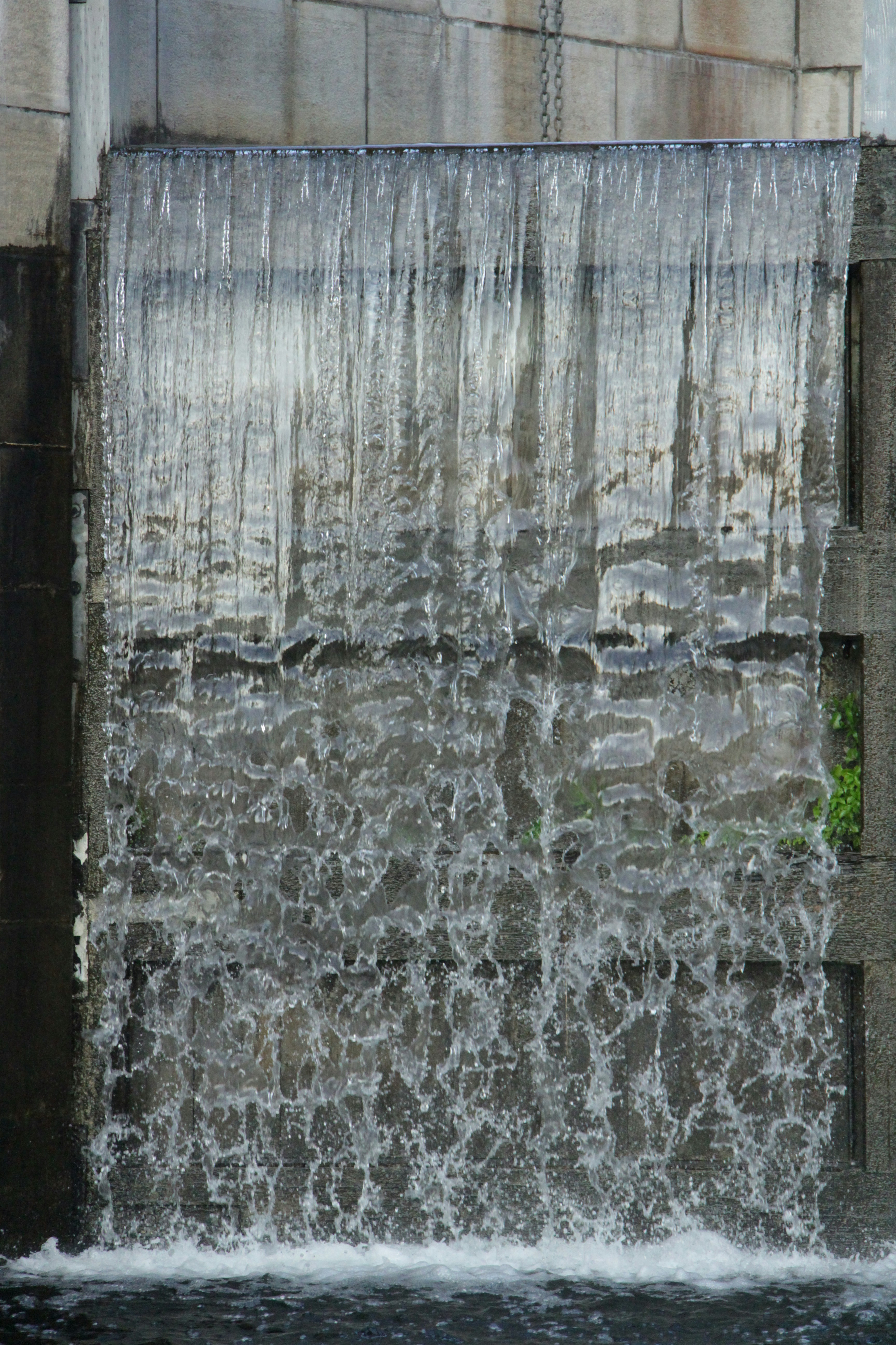 Water cascading down a concrete wall
