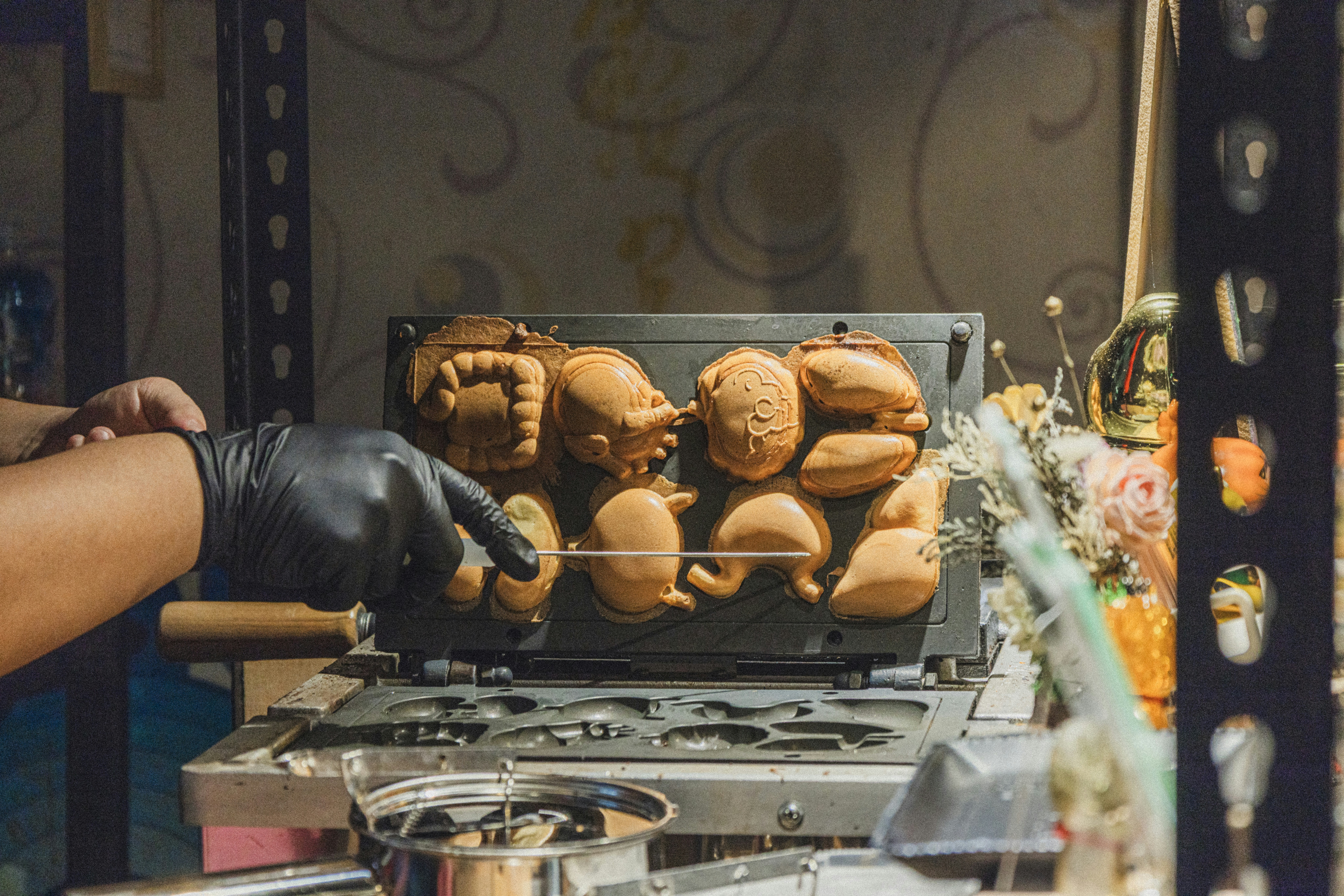 Industrial Waffle Wizardry: Hands and Hot Plate in Focus