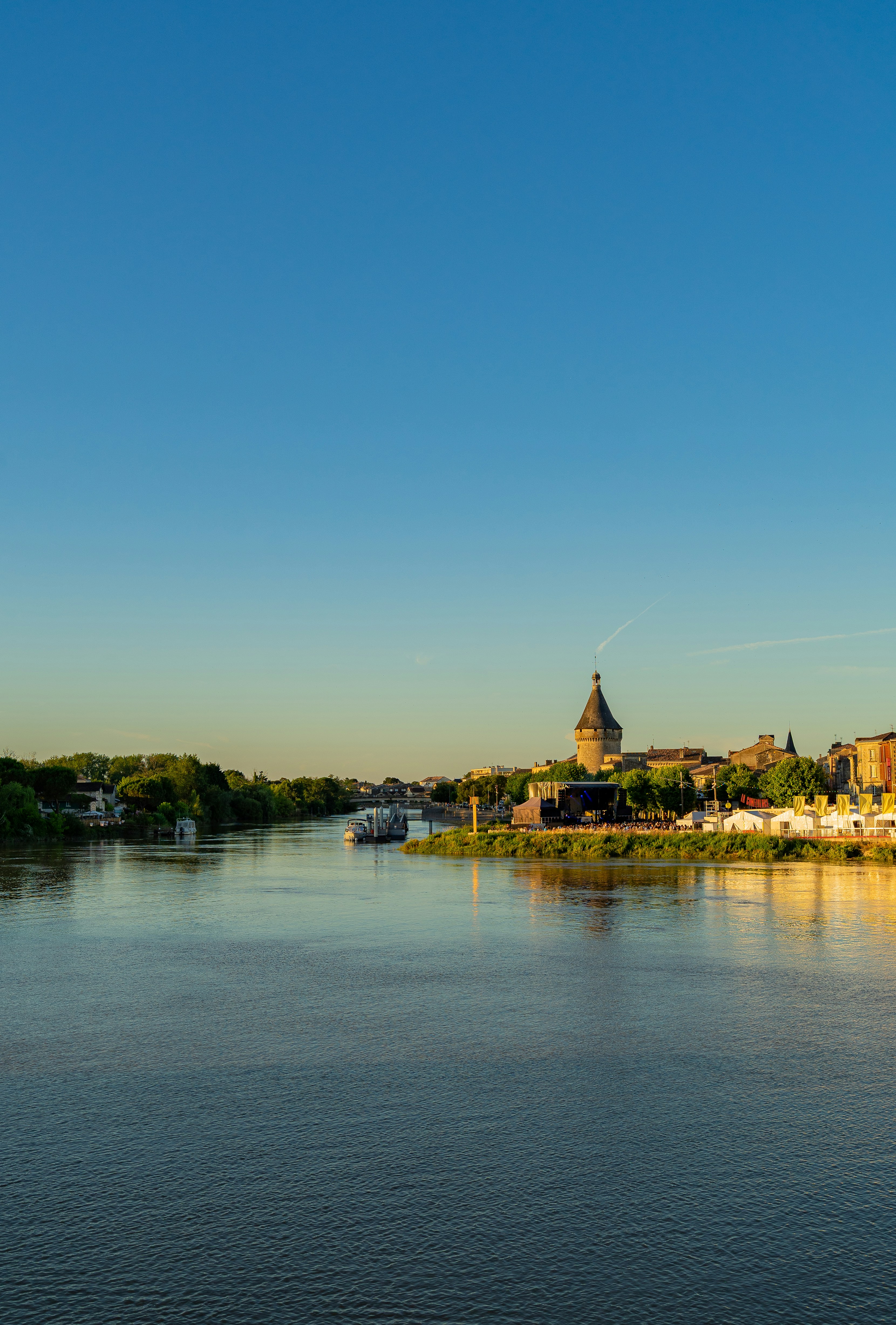 Sunlit Bend: Church Tower Framing a Quiet River
