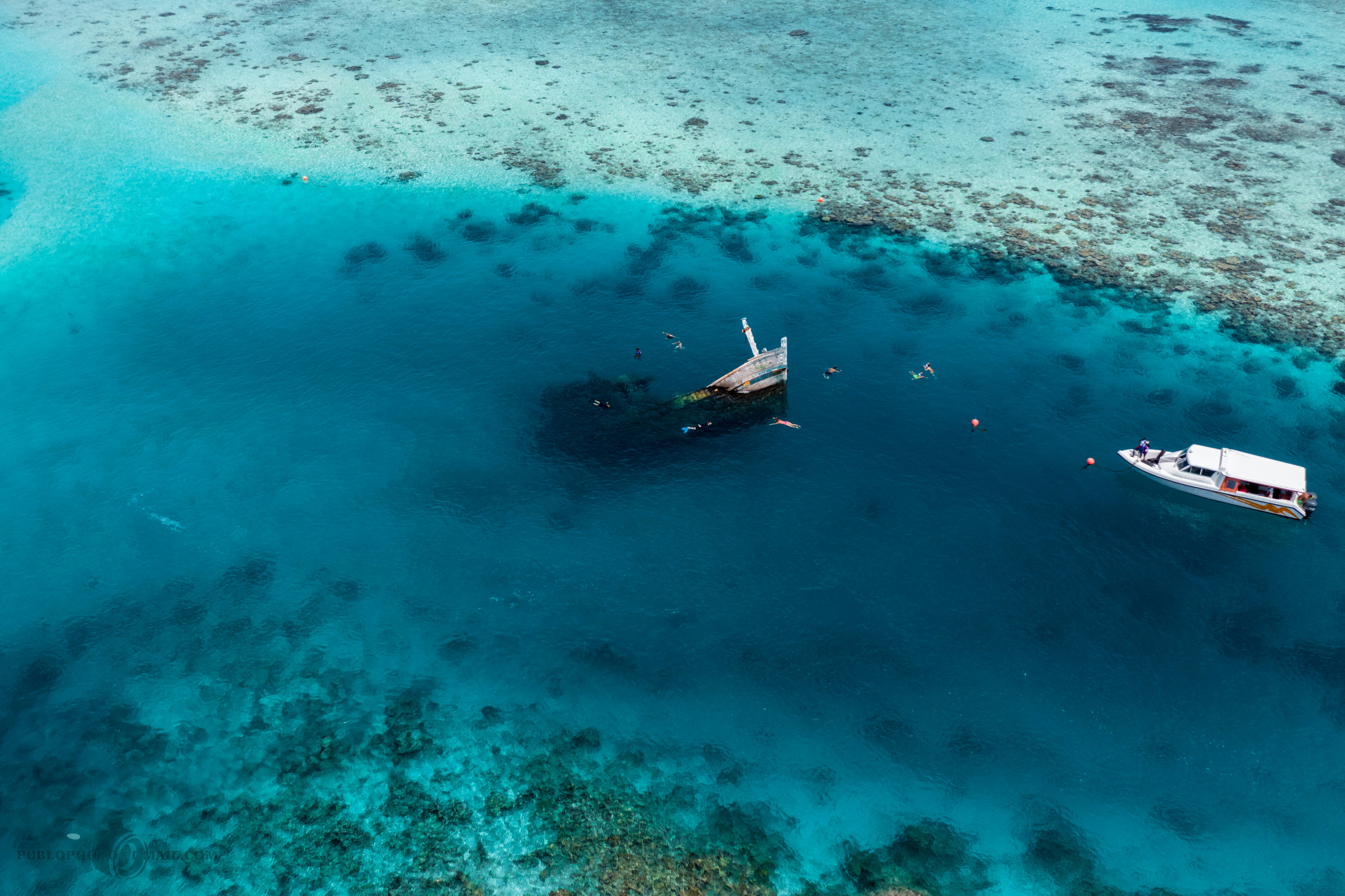 Lost Sail or Silent Reef: Aerial View of a Sinking Structure in Turquoise Waters