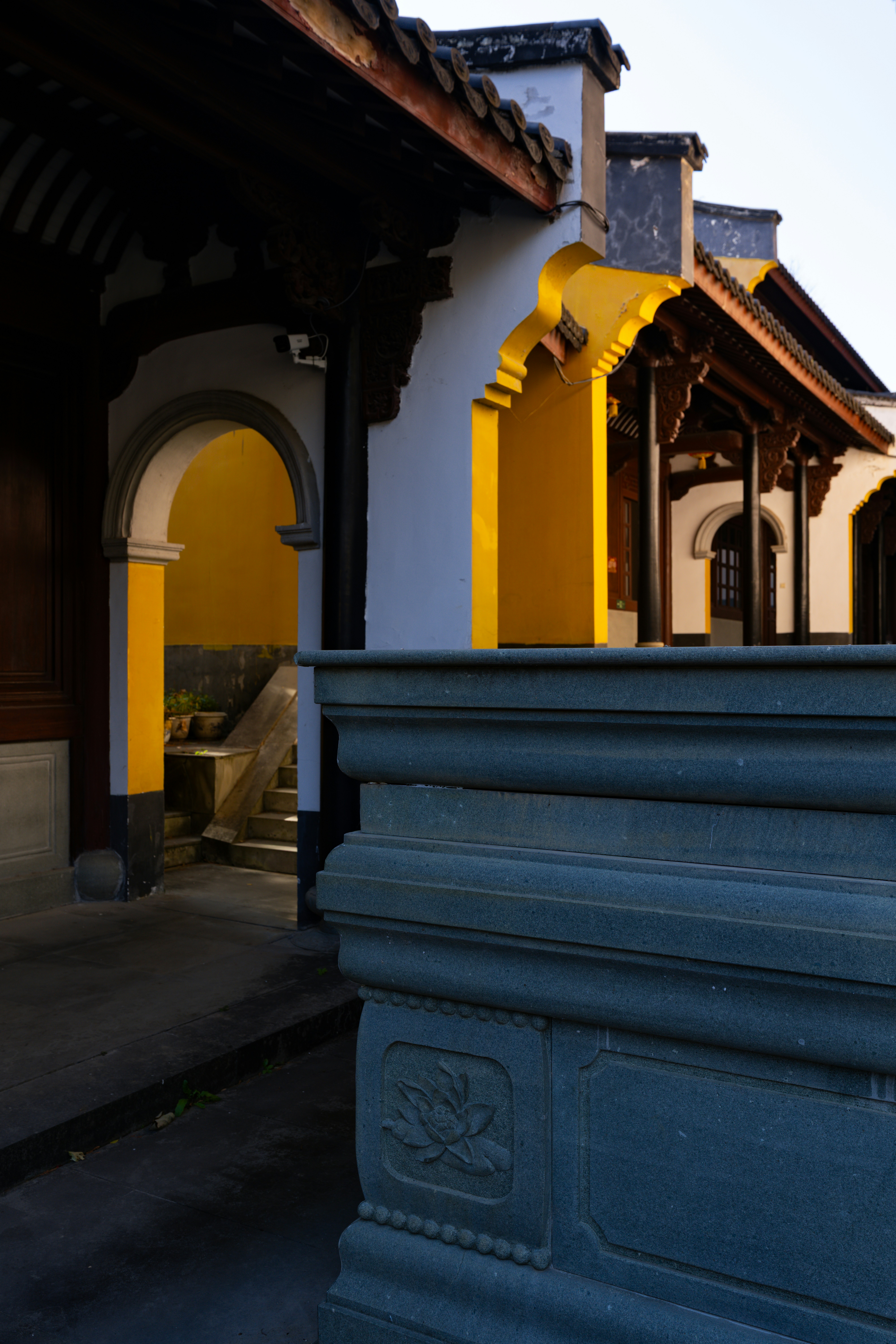Golden Archways and Blue Rail: Evening Light on a traditional courtyard