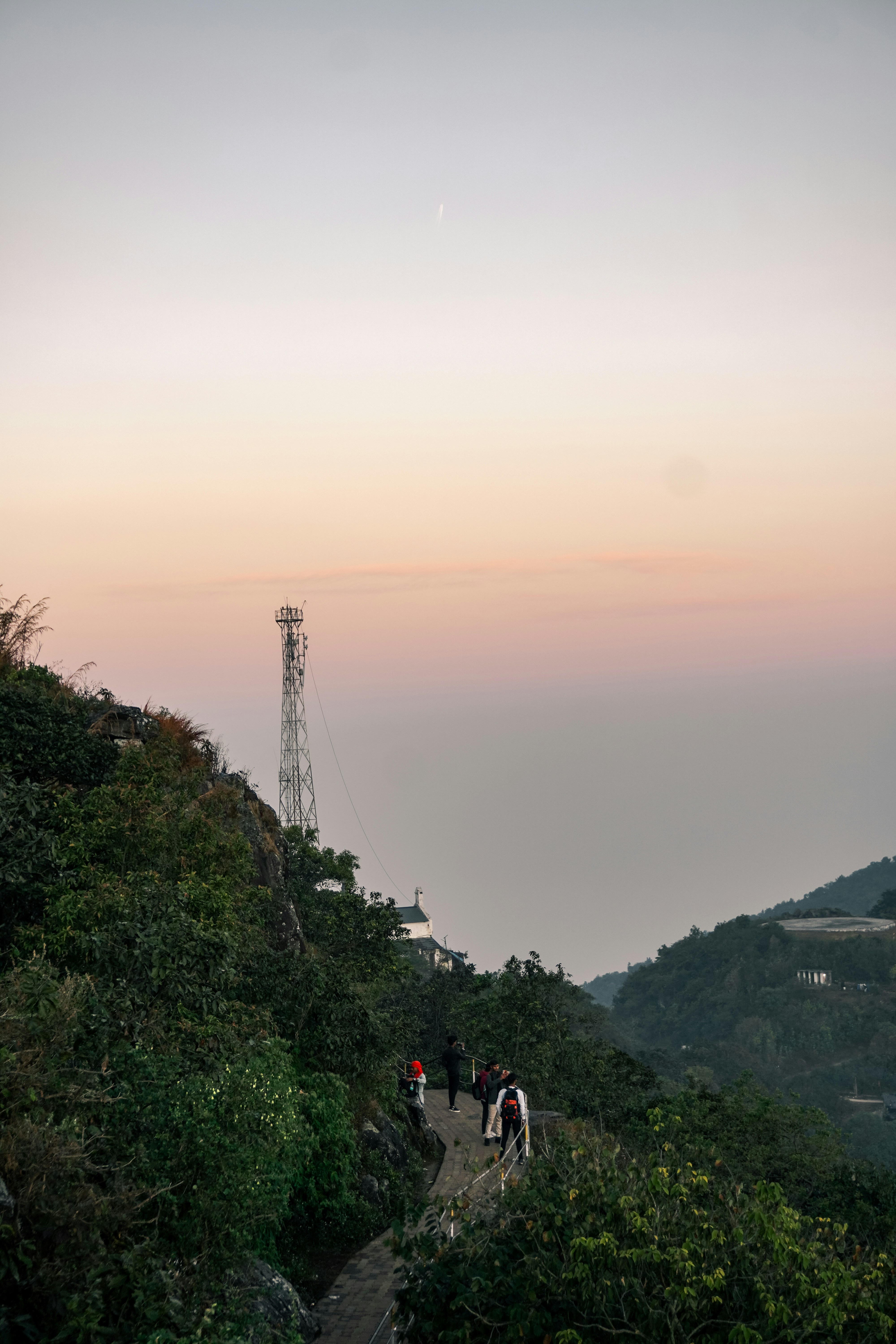 Trail at Dusk: A Cliffside Path Under Gentle Haze