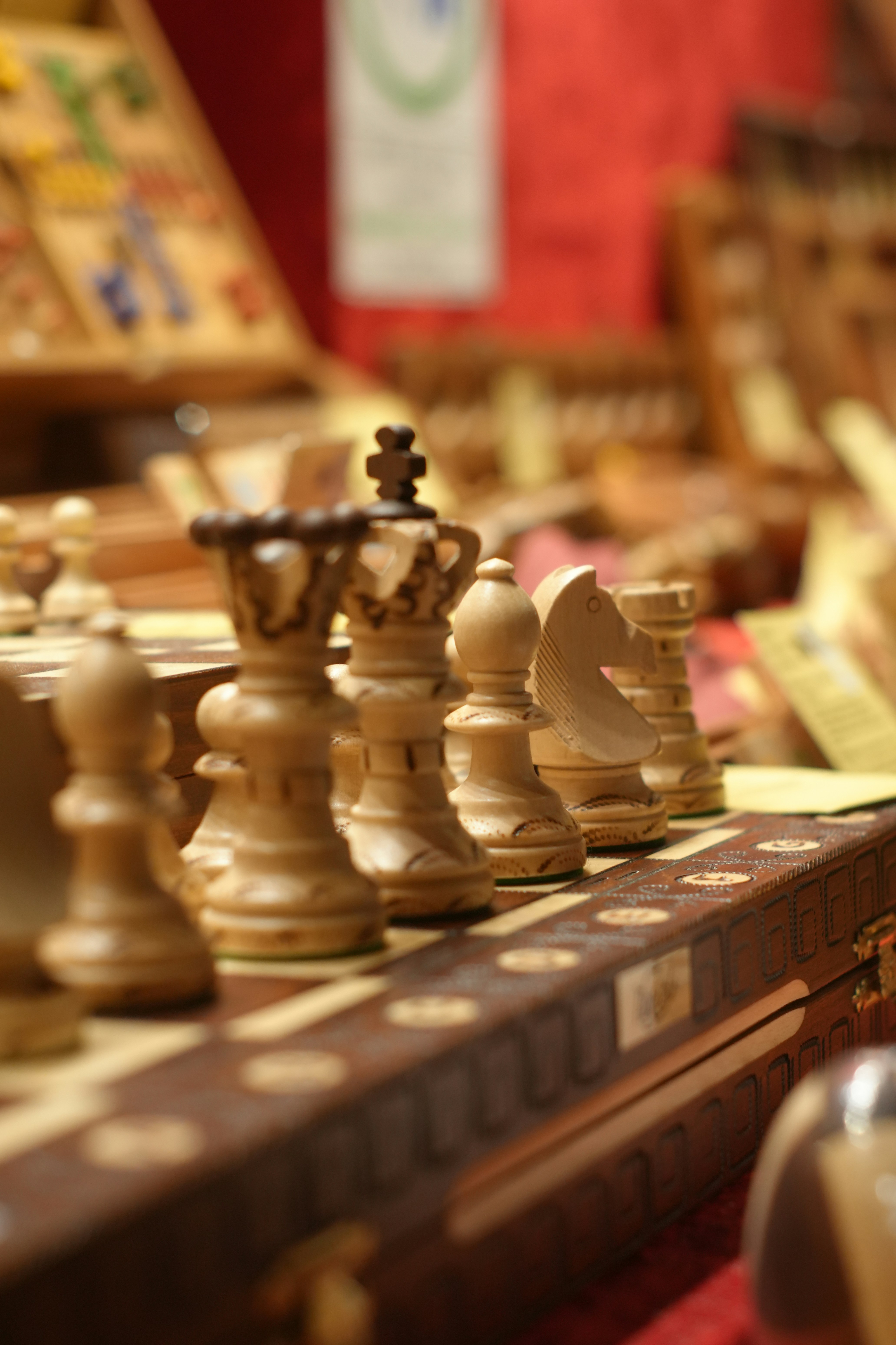 Focused Game of Pieces: A Row of Chessmen in a Warm Market Stall