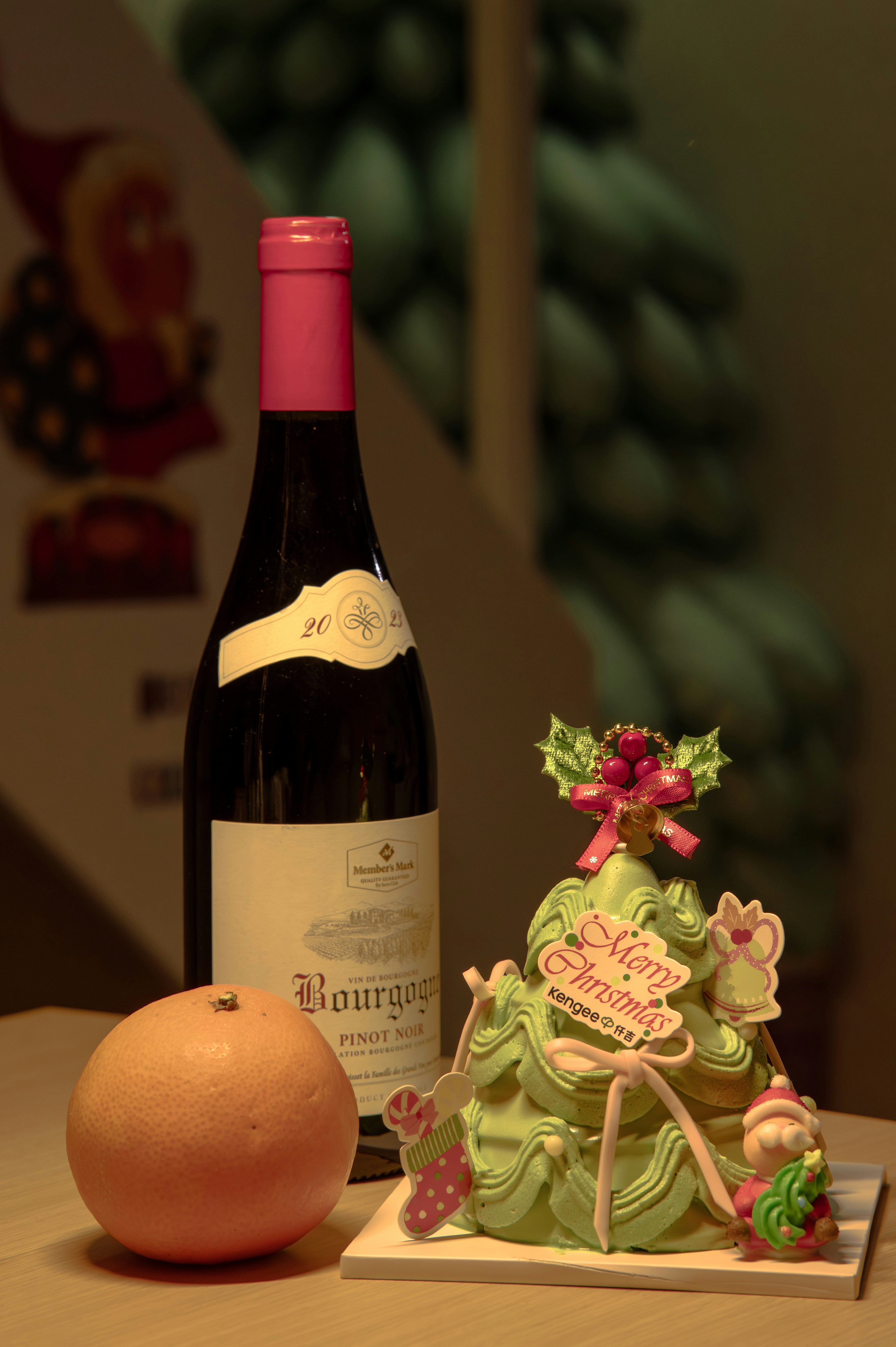 Celebratory Still Life: A Bottle, Citrus, and Festive Tree