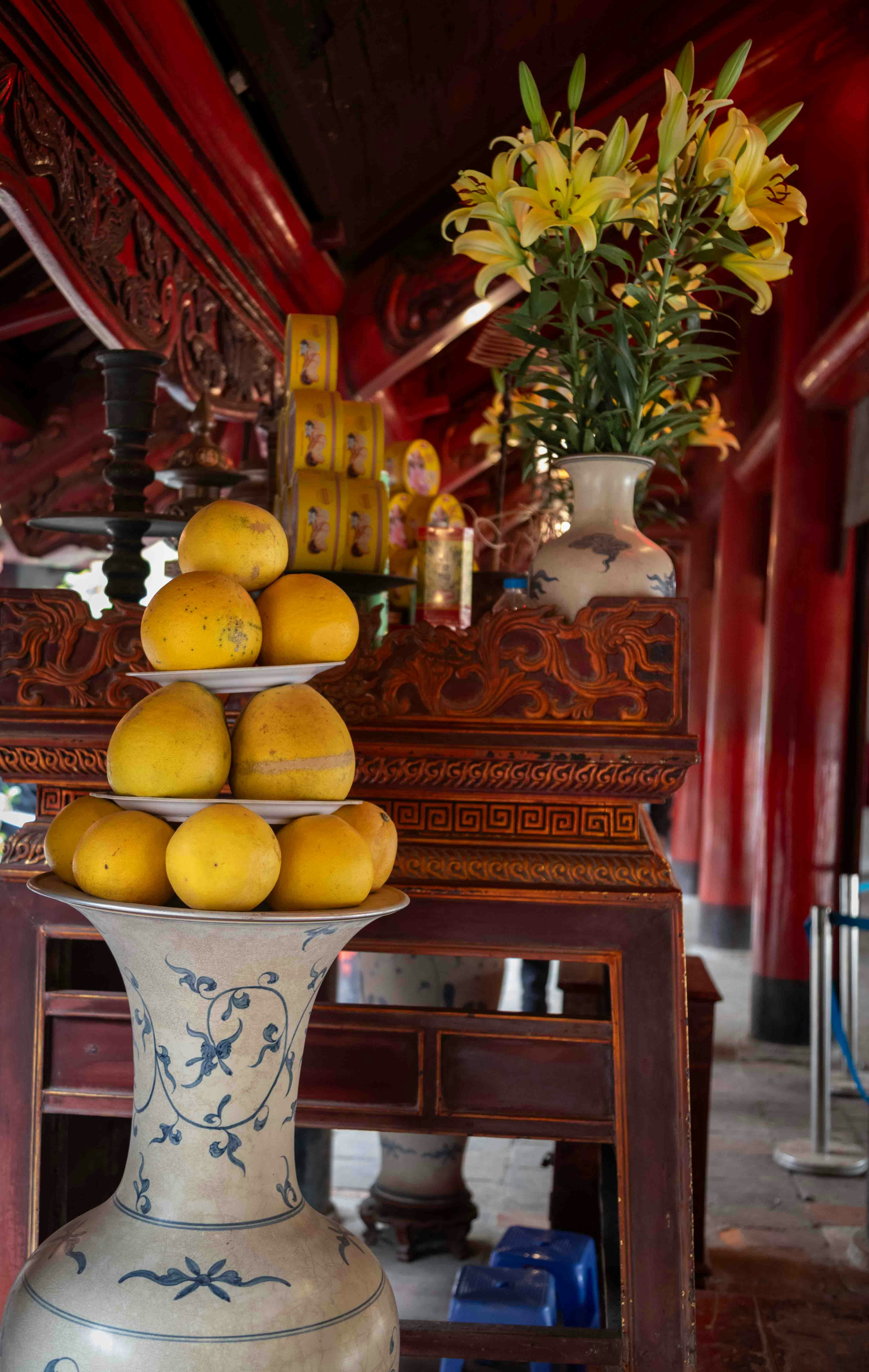 Towering Citrus Offerings in a Red-wood Shrine