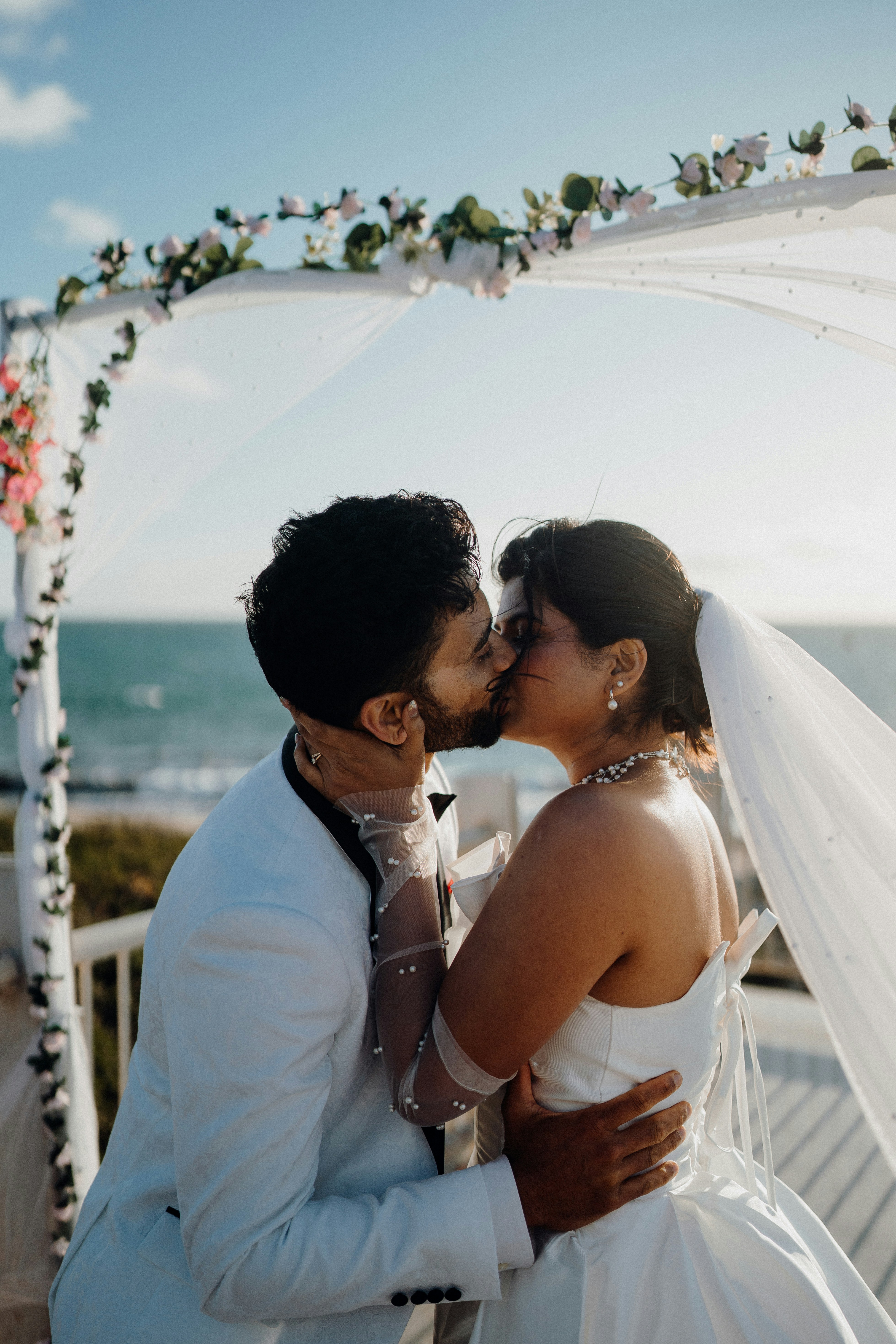 Kiss Beneath the Floral Arch by the Sea
