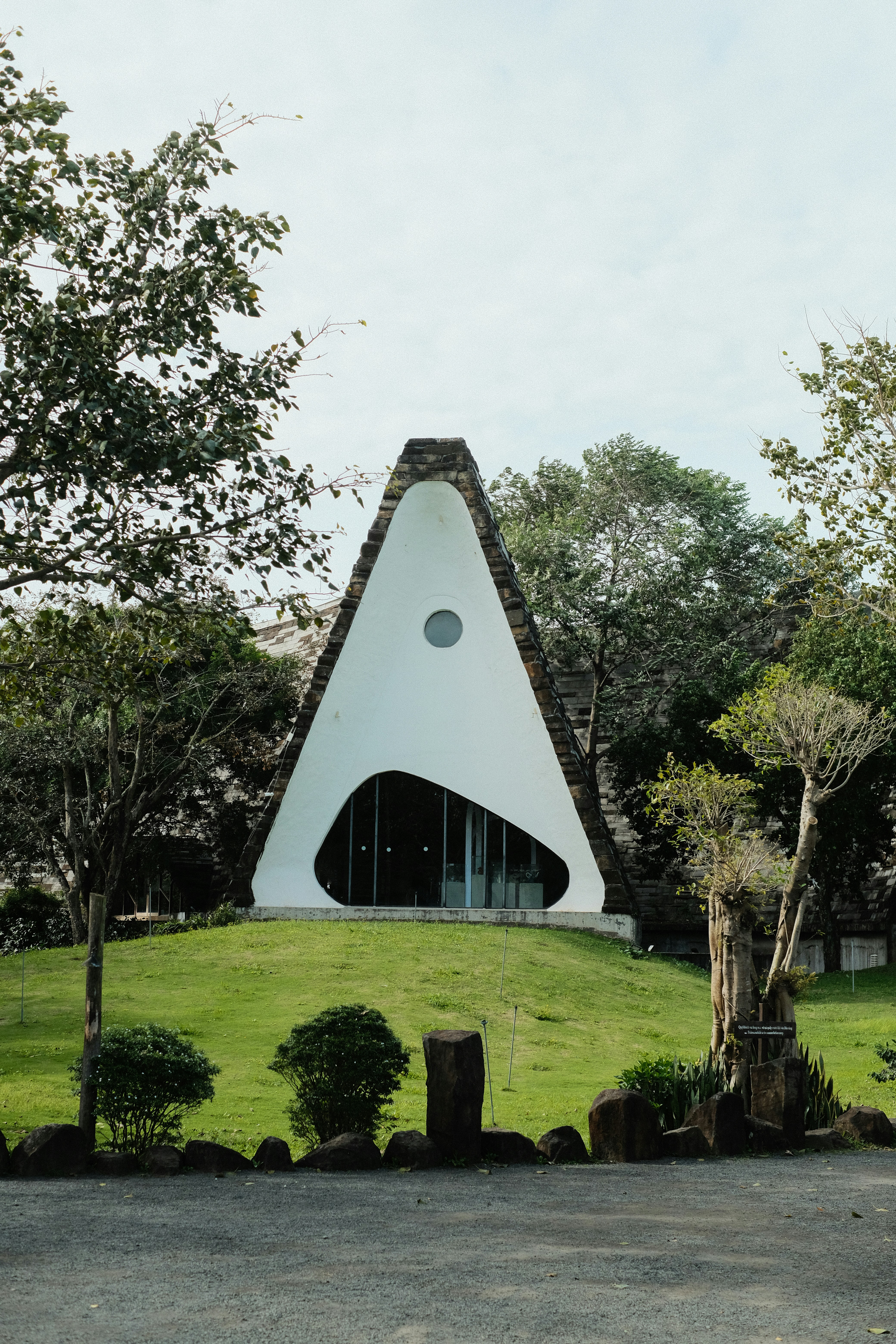 A Triangular Facade Emerges from the Greenlayed Hill