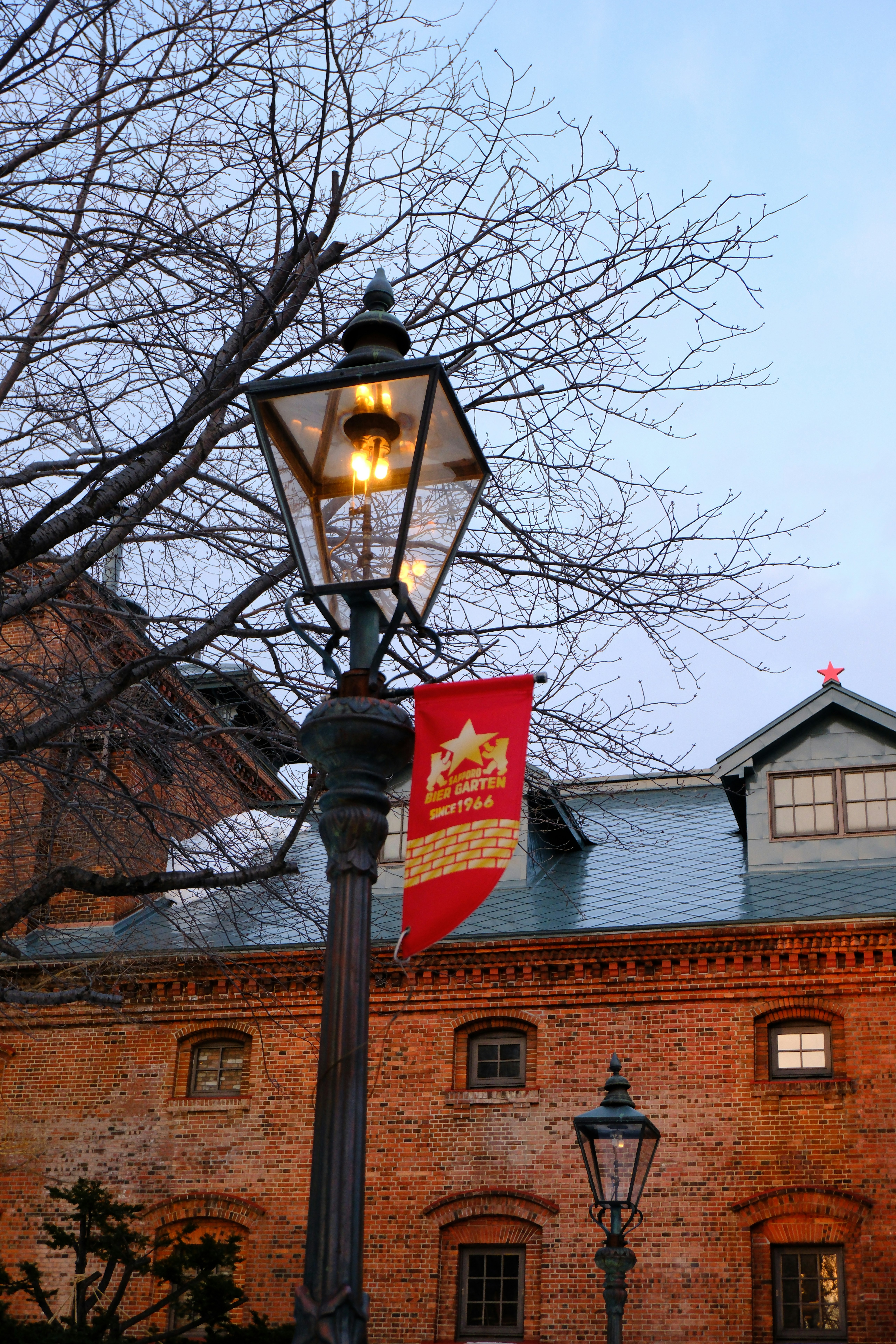 Urban Lanterns and Brick Tower: A Quiet Evening Banner