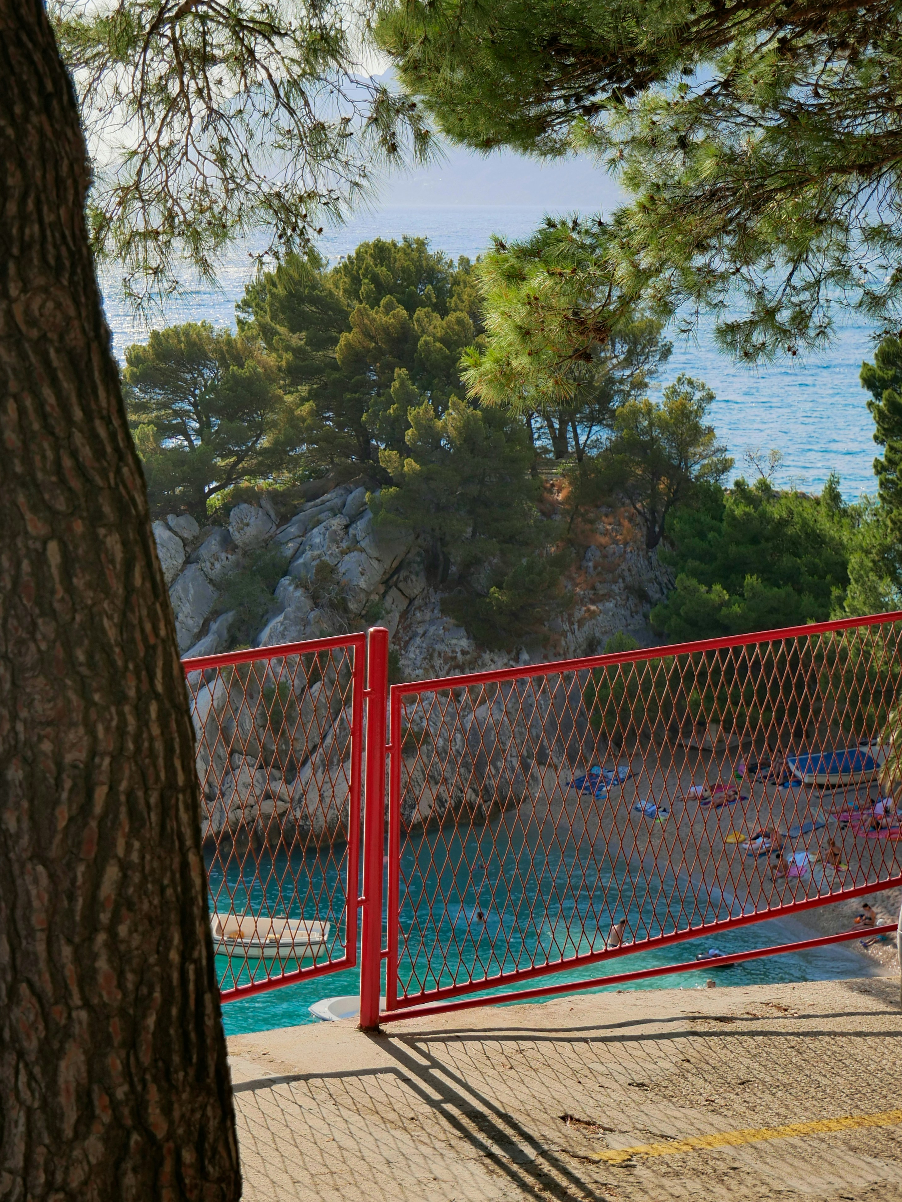 Red Gate Overlooking a Seaside Cove