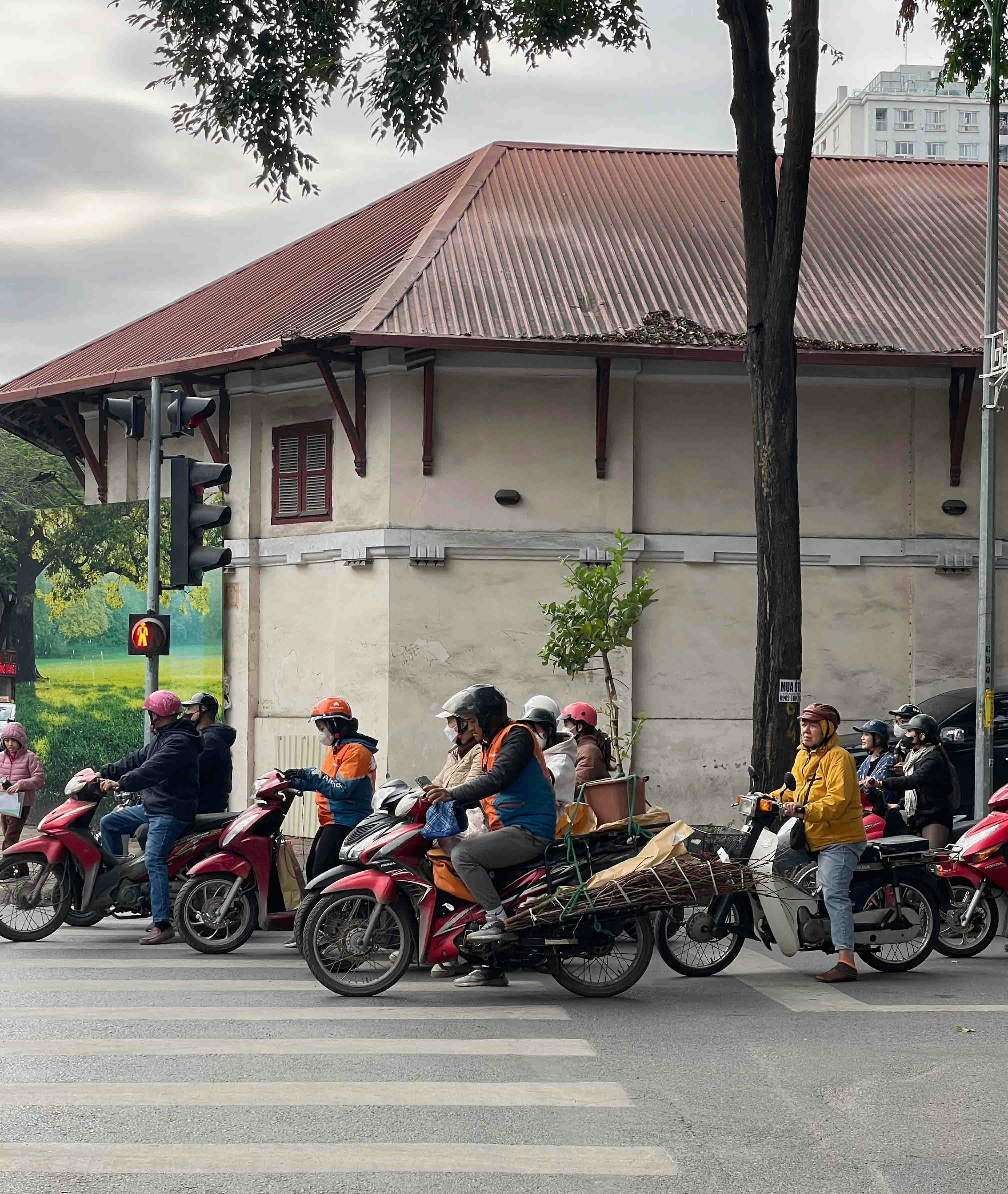 Congregation at the Corner: Motorbike Parade by a Riverside Structure