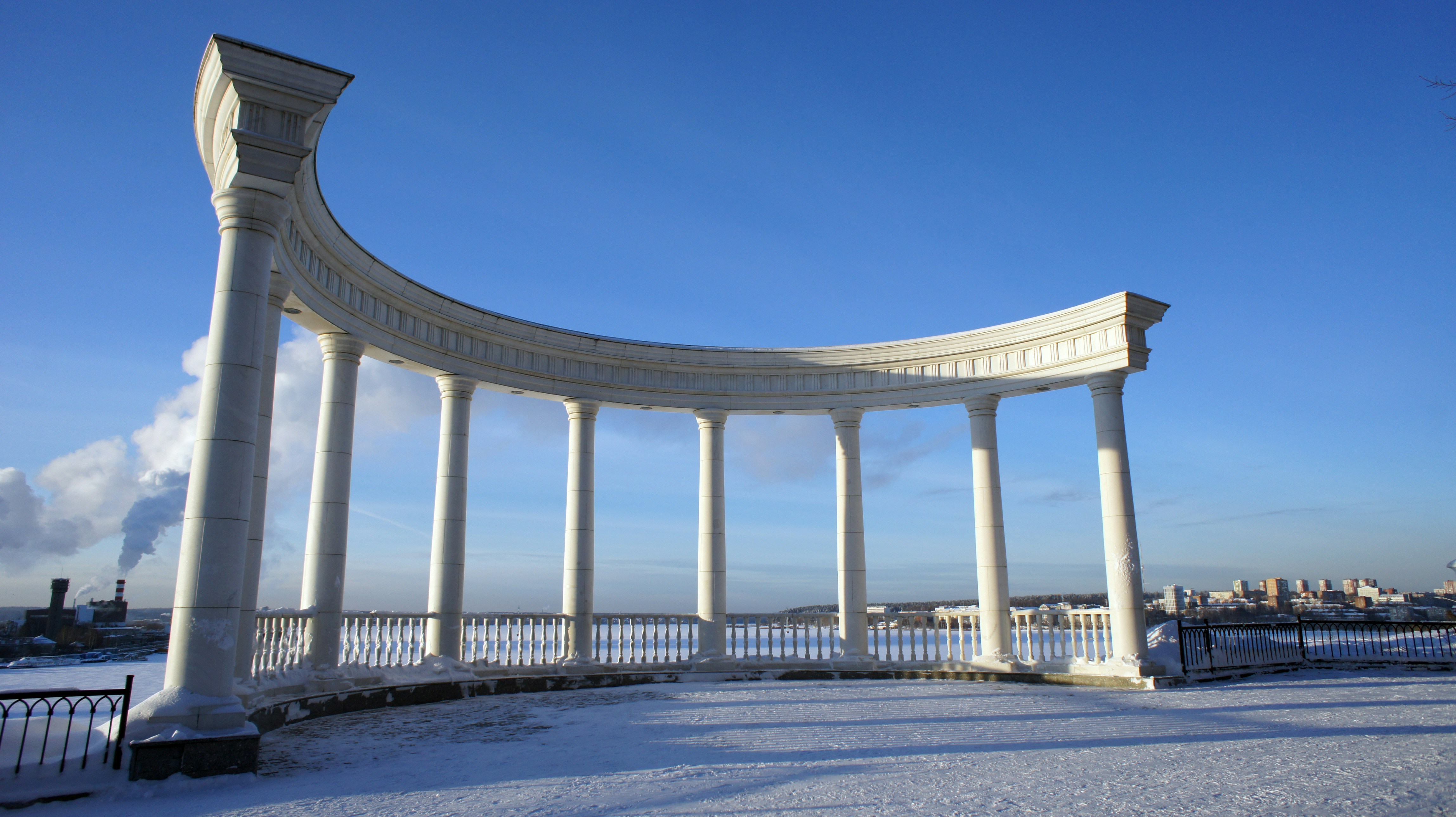Curved Harbor Terrace: White Colonnade Against a Clear Winter Sky
