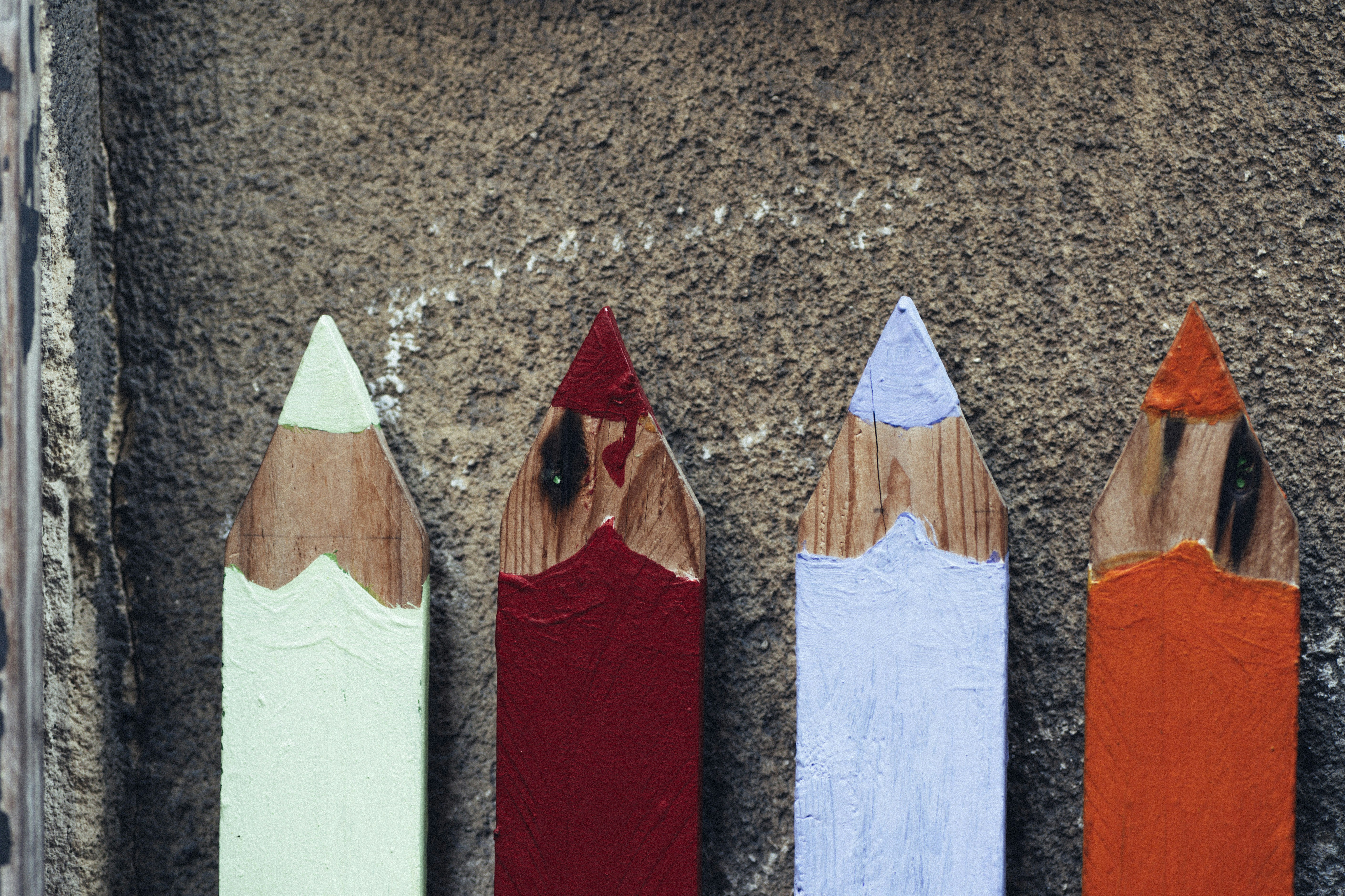 Split-Color Pencils: A Row of Painted Sticks with Tapered Tips