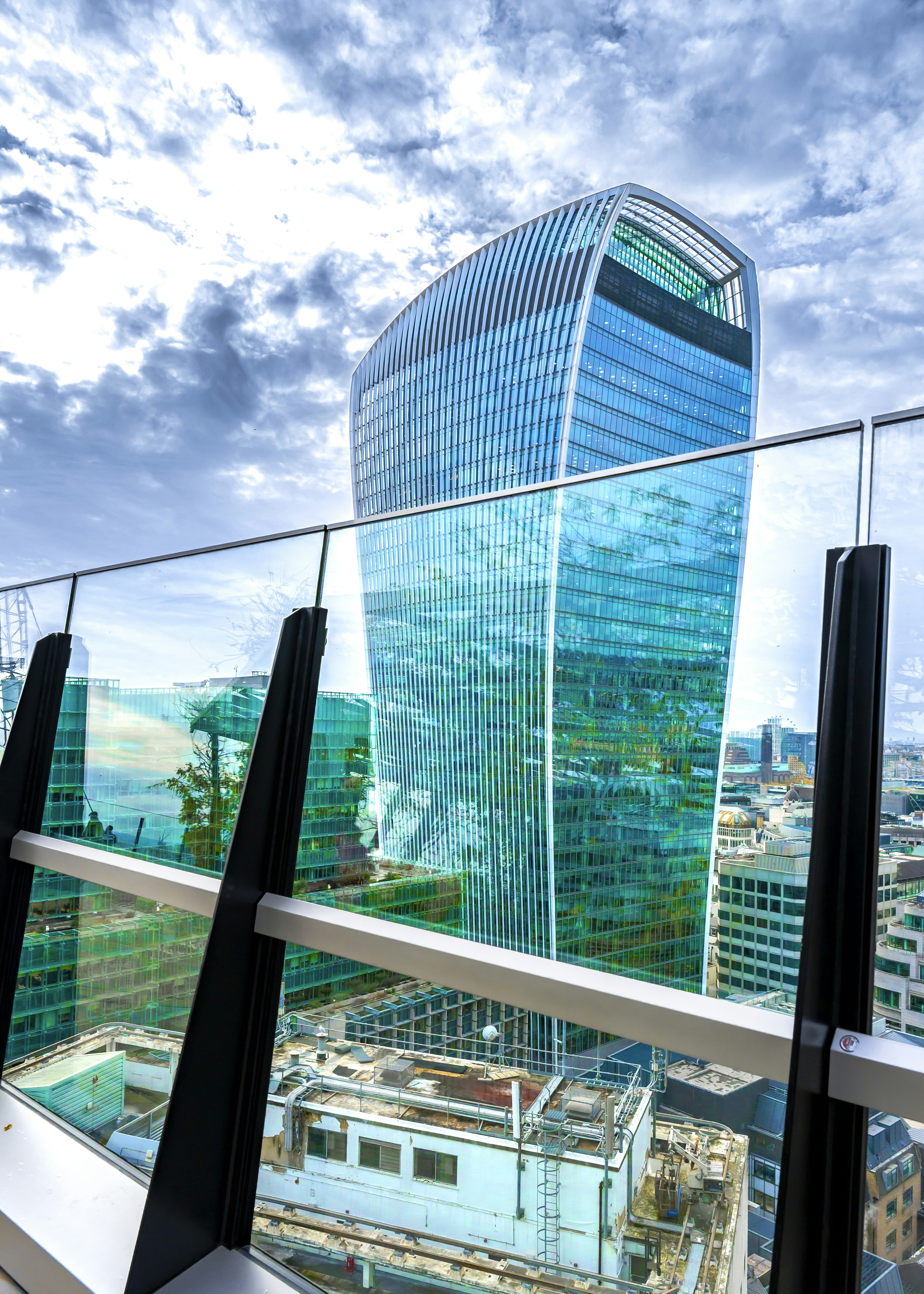 Skyward Glass: The Blue Tower from a Rooftop Edge