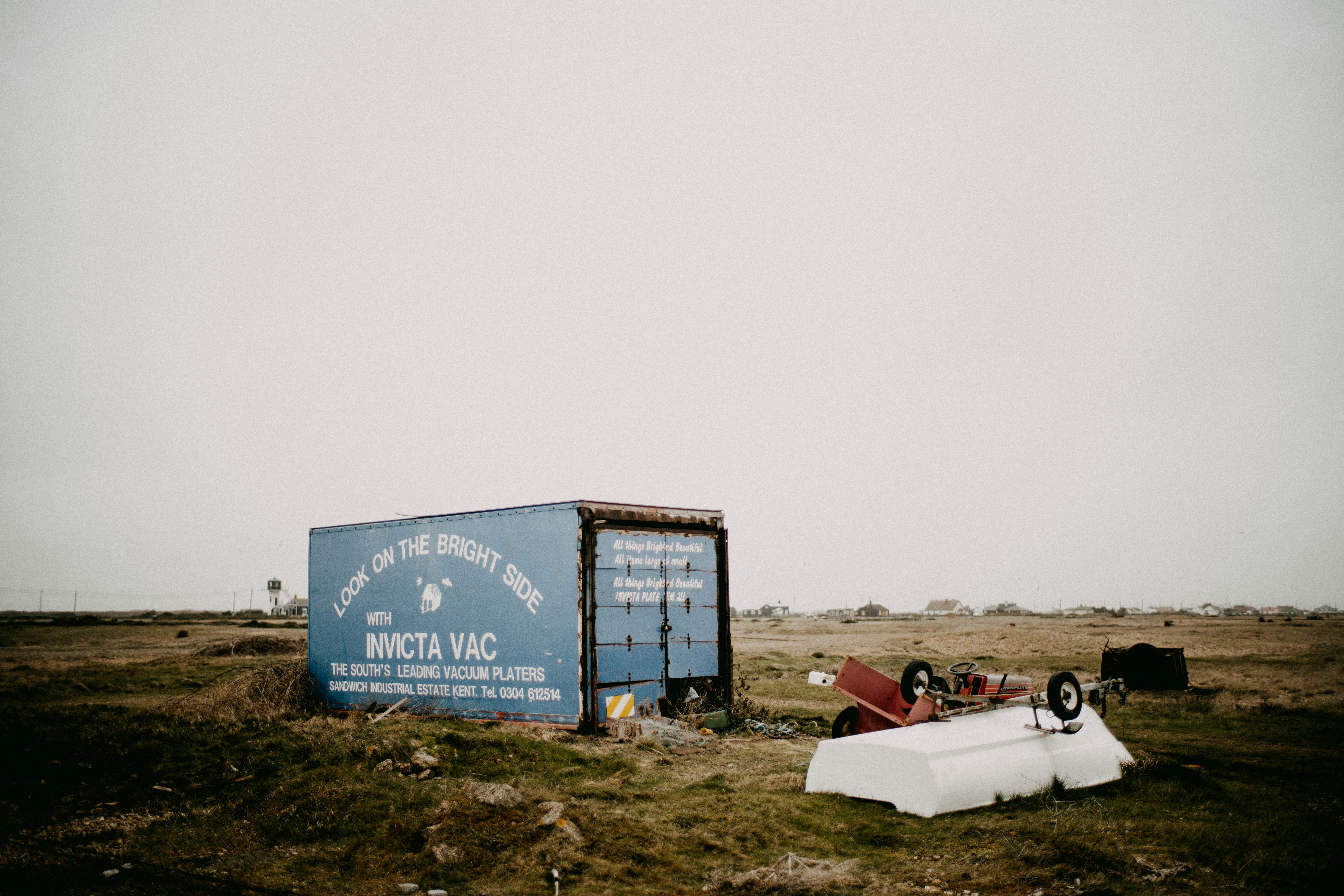 Deserted Landing: A Rusted Shelter and Abandoned Farm Debris in Barren Plains