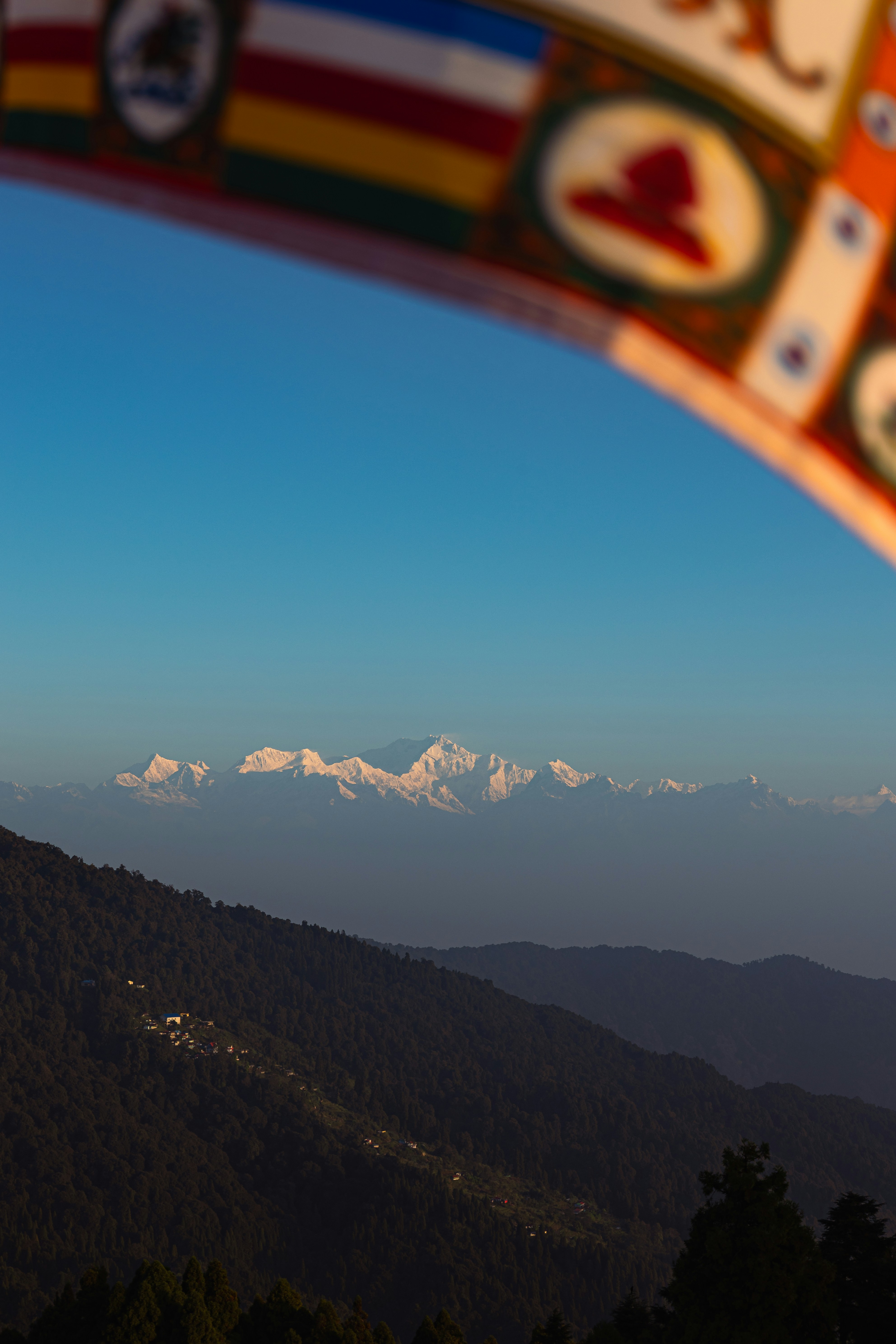 Snow-capped Peaks Rise Above a Curved Colorful Arch