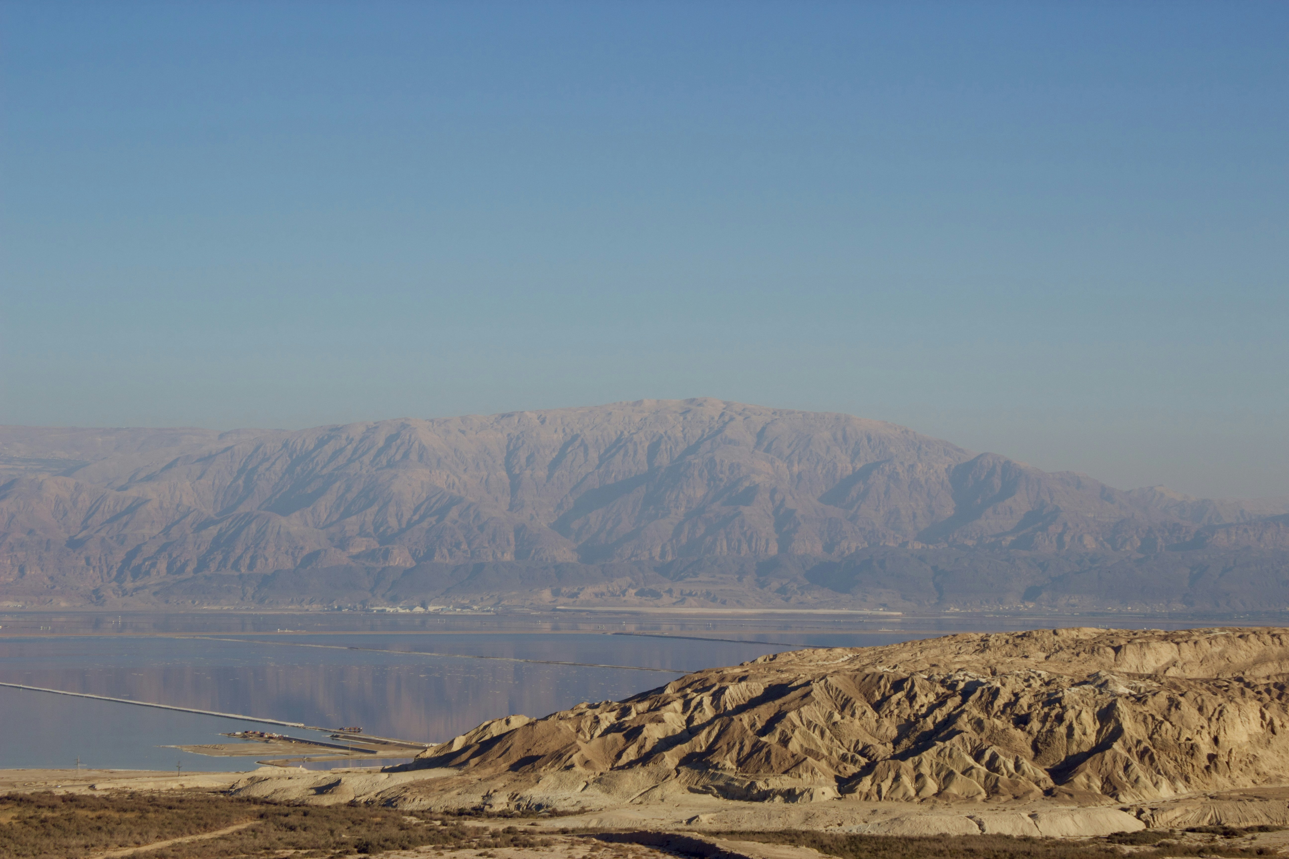 Desert Coastline with Mountain Backdrop at Dusk