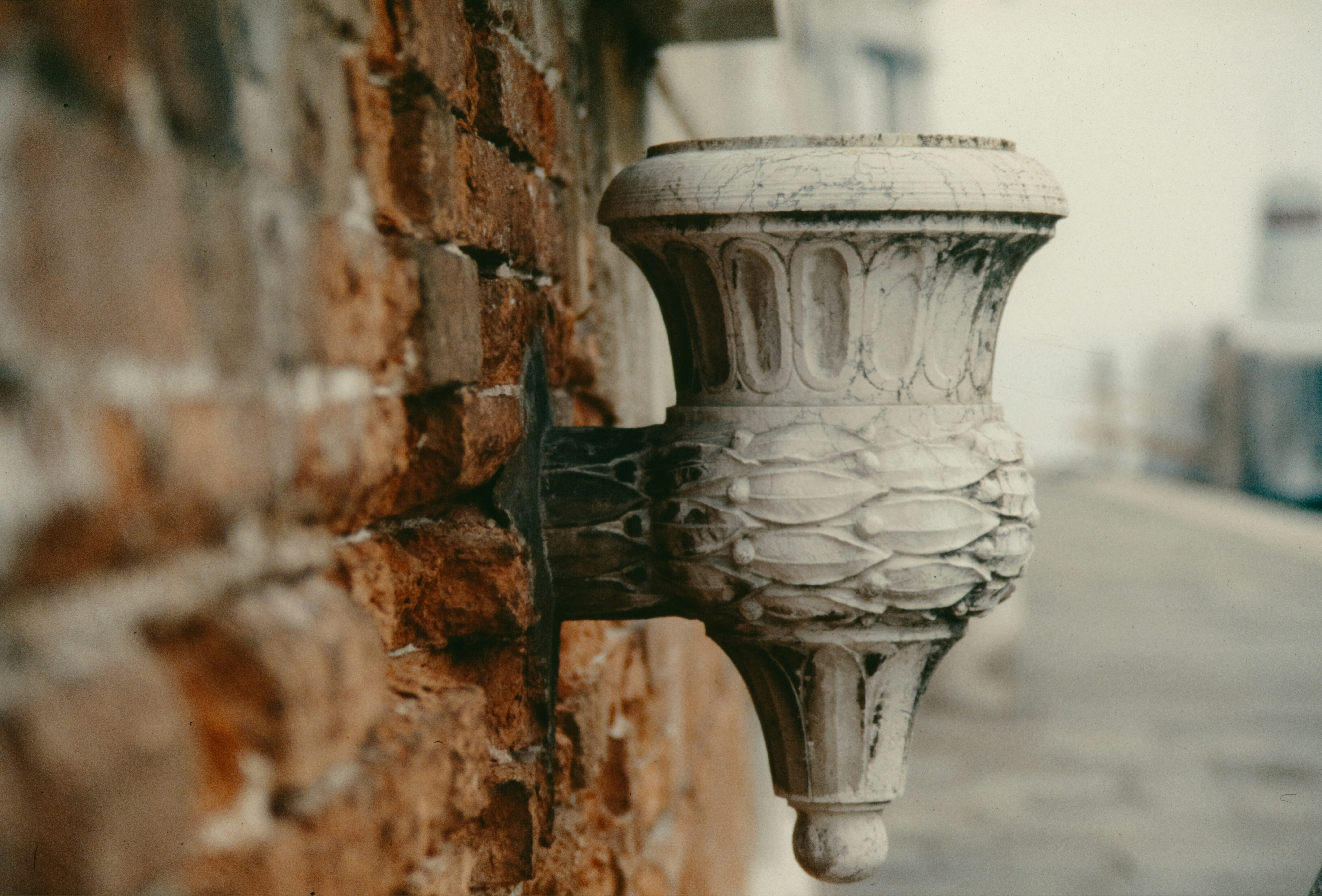 Ancient Spout Against a Brick Vein