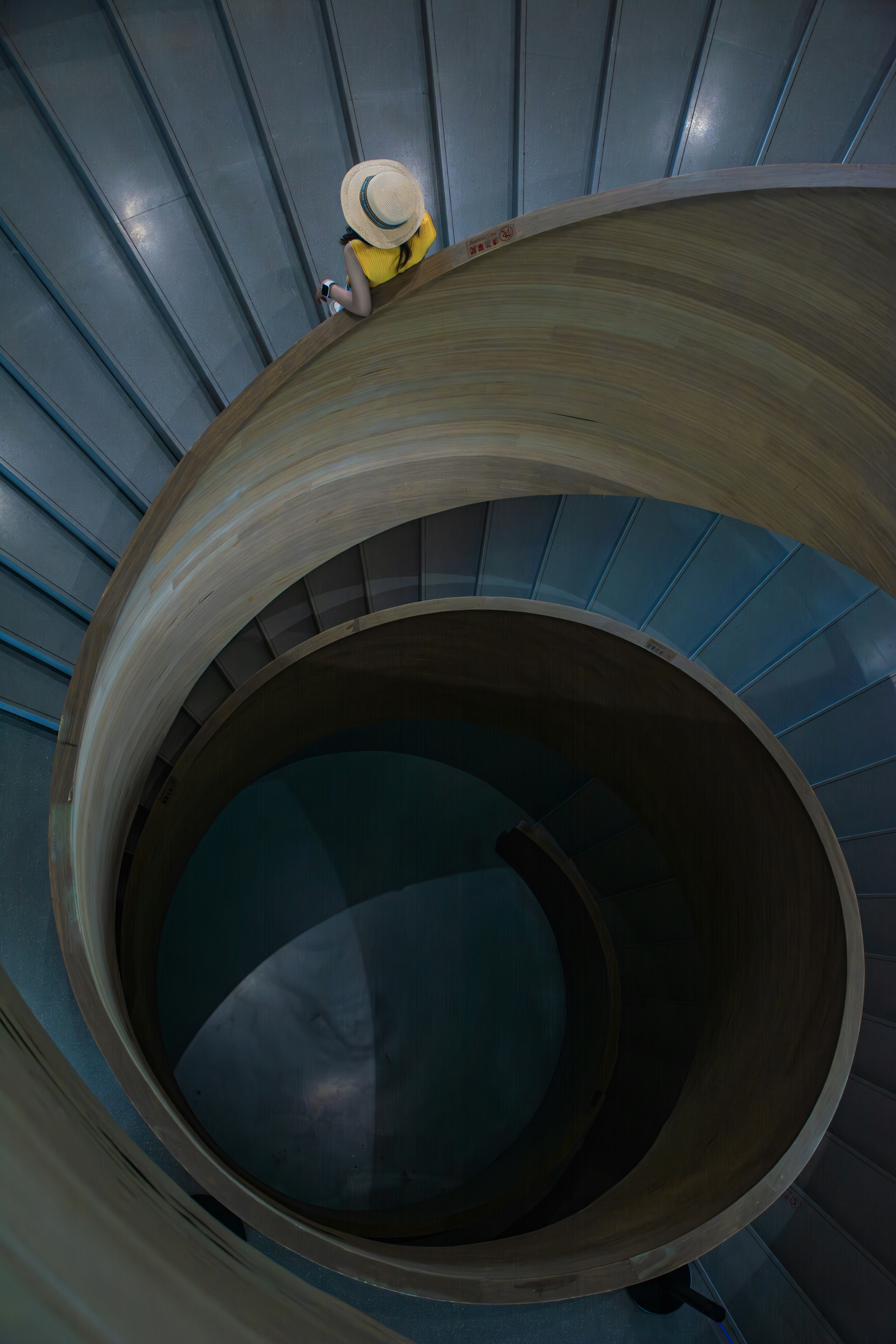 Spiral Descent: A Staircase’s Quiet Vigil Above the Coiled Core