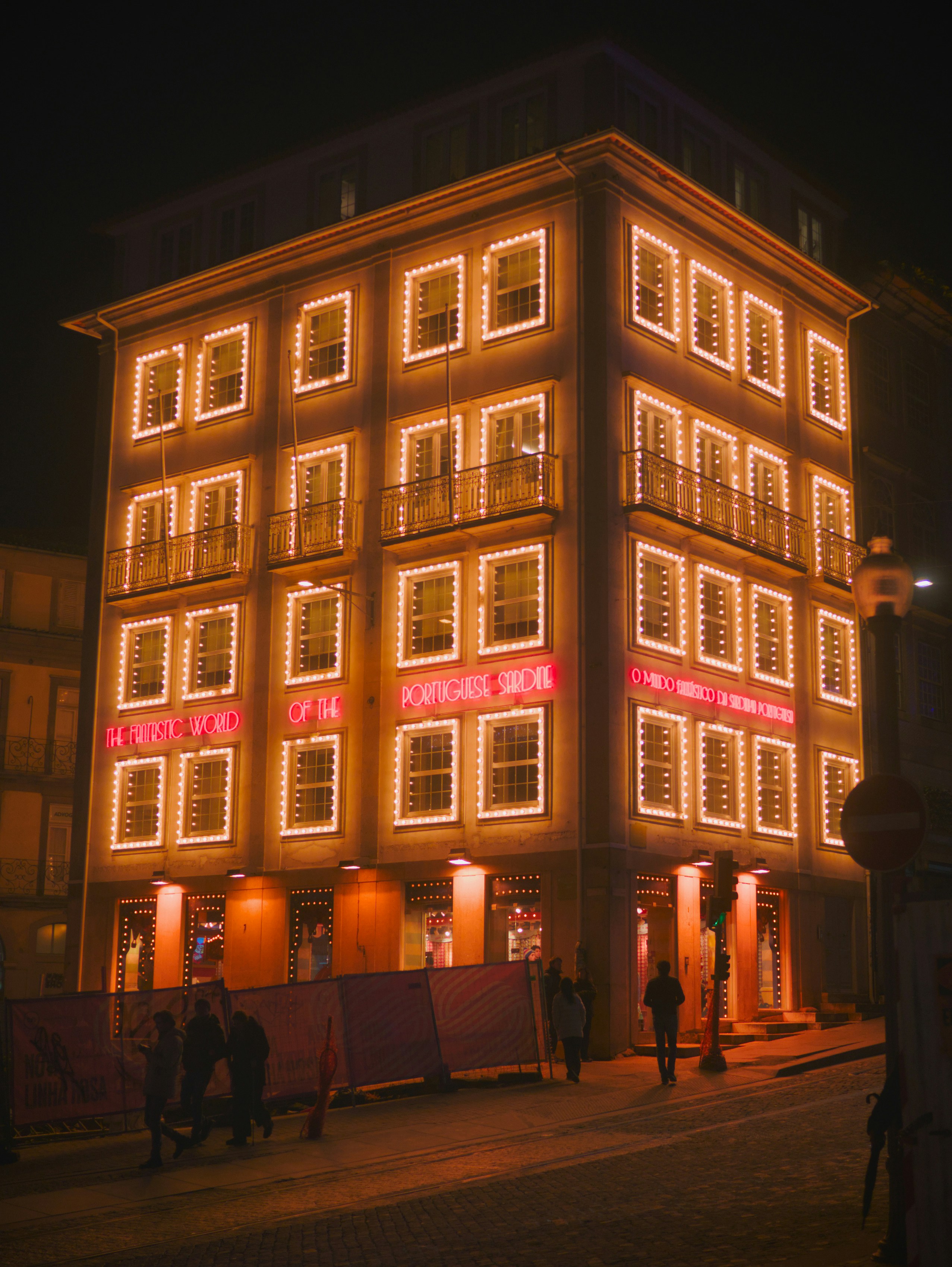 Neon Facade: A Staged Night in a Warmly Lit Corner Building