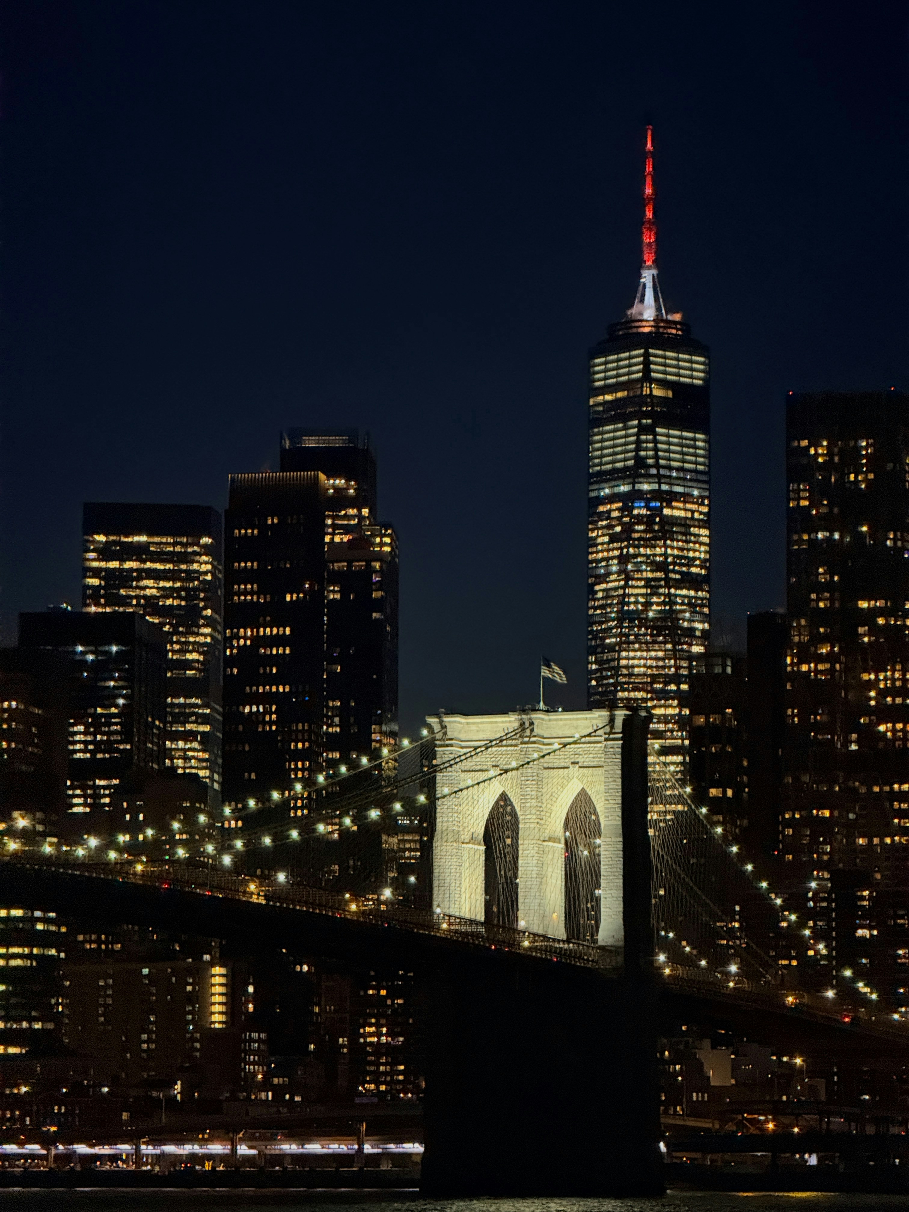 City Lights on the Brooklyn Bridge: Nighttime Skyline Embrace