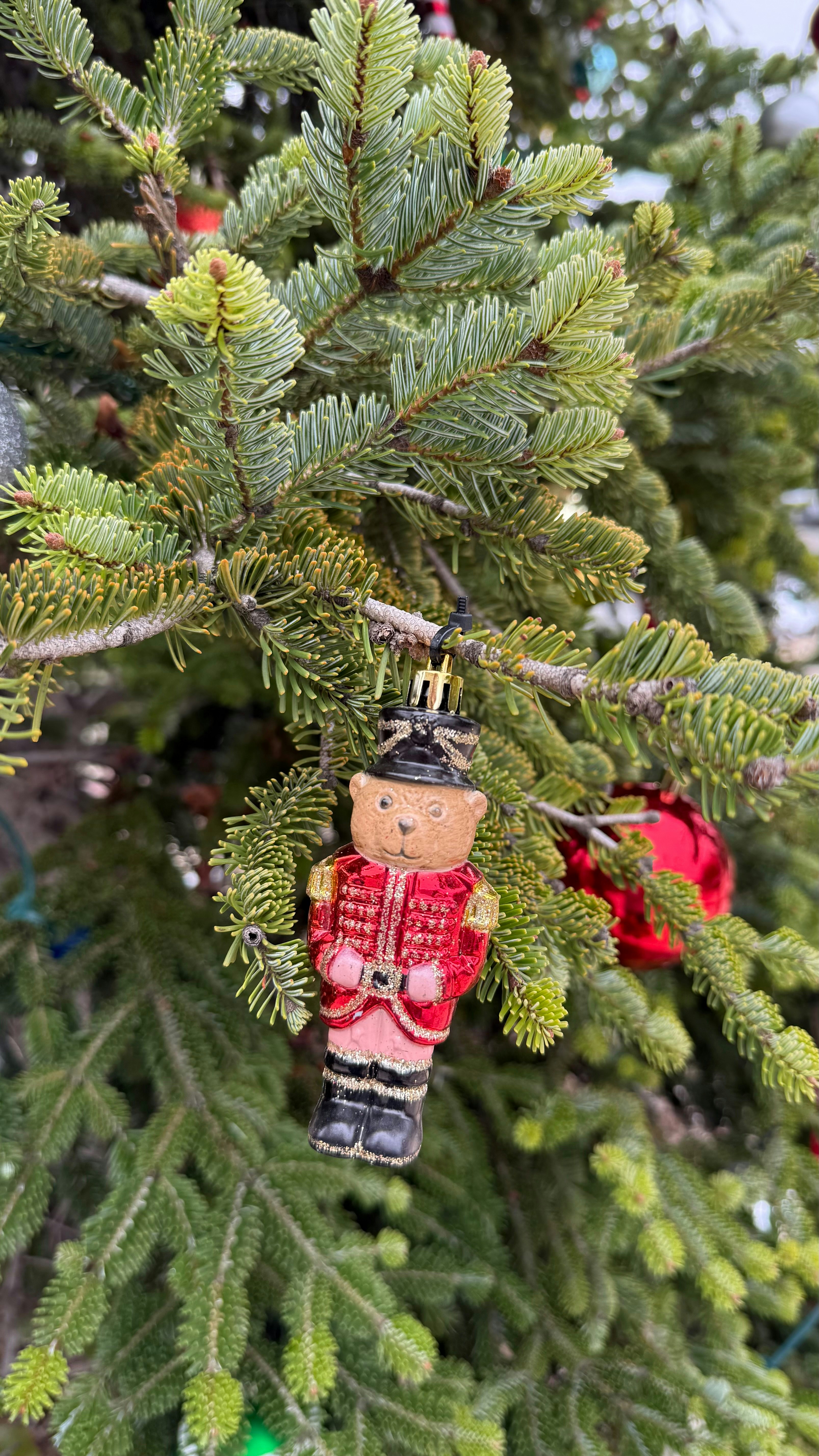 Nutcracker Ornament Nestled in Pine
