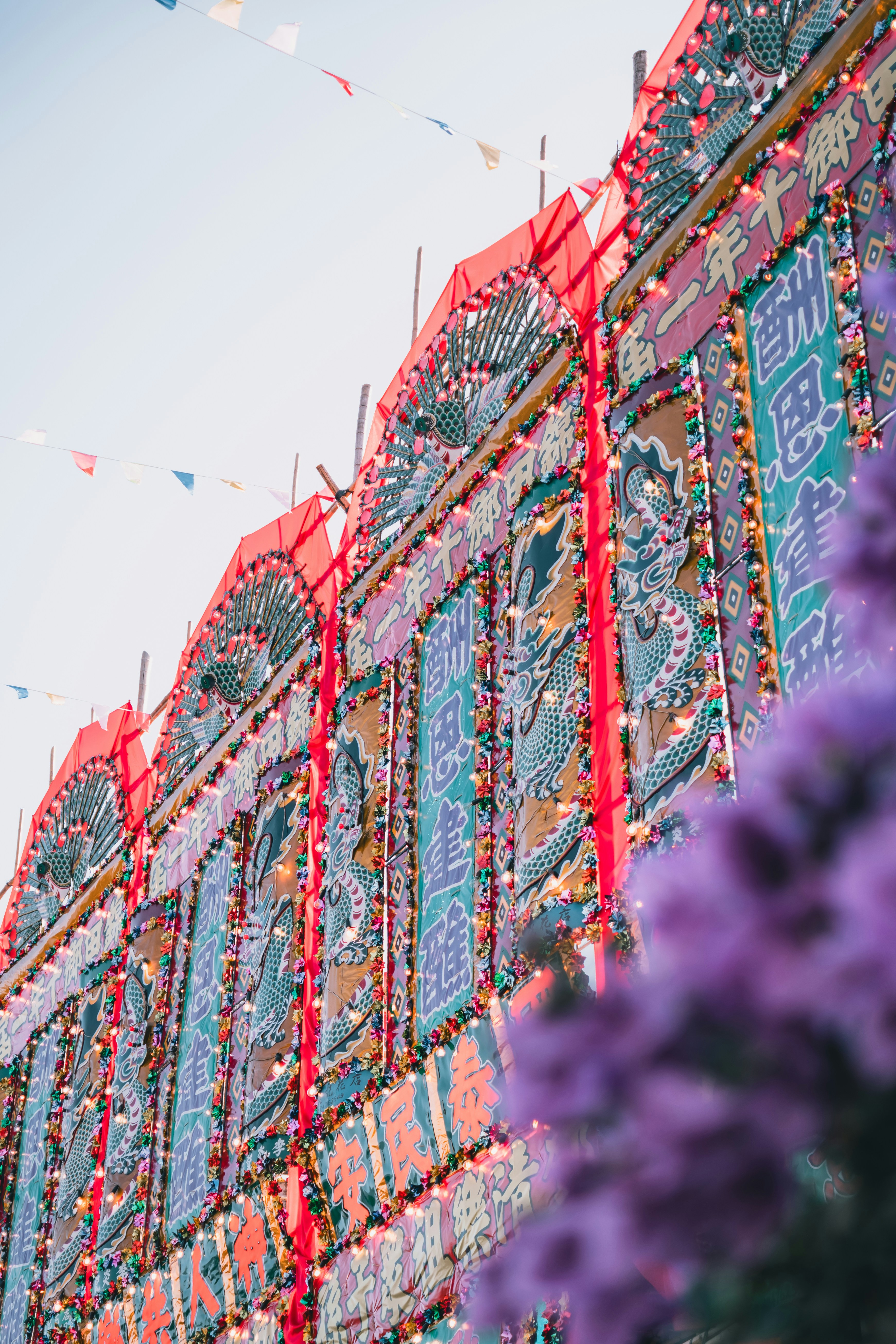 Street Fest Banners in Motion: Colorful Facade and Blooming Foreground