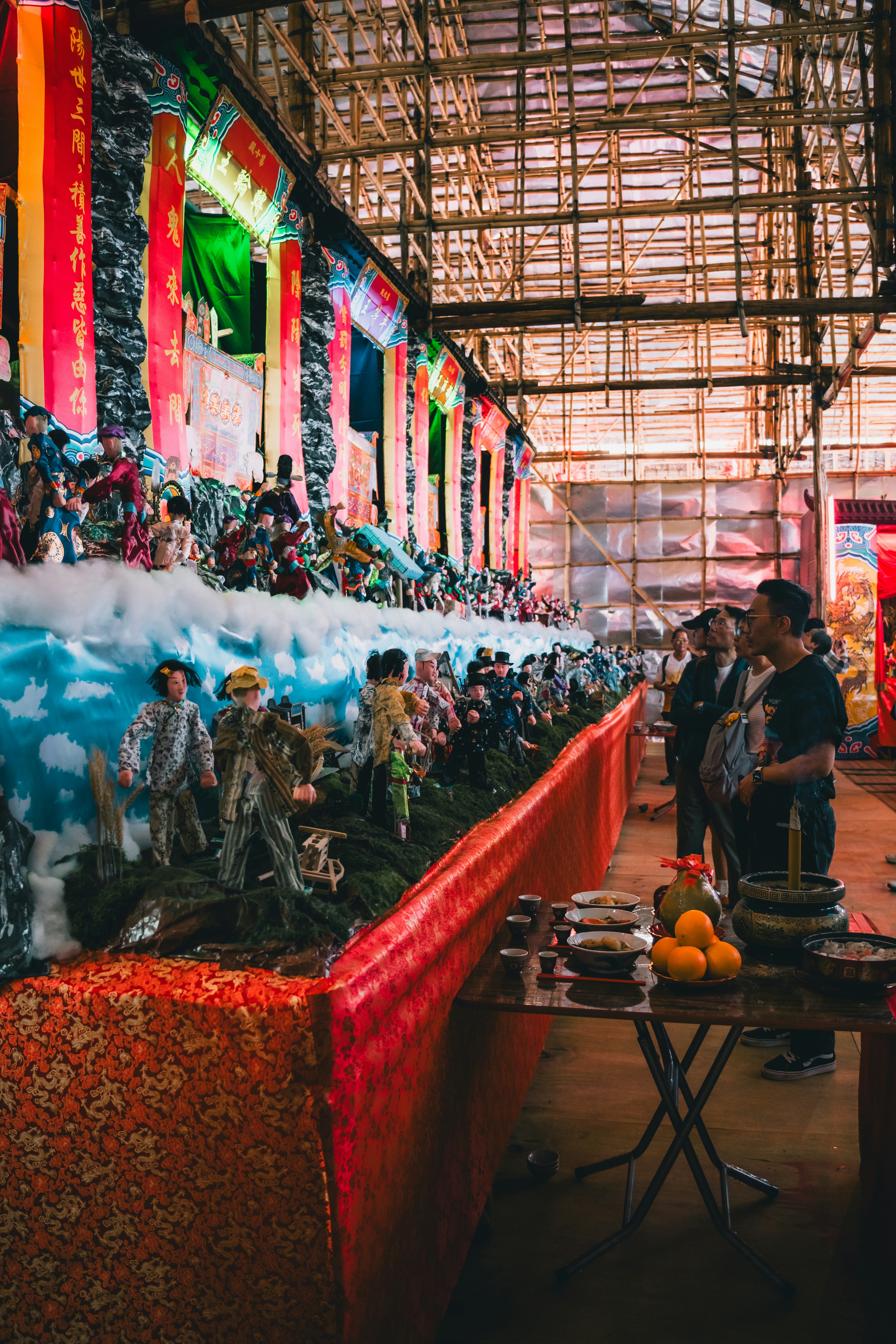 Procession of Lanterned Figures: A Colorful Spectacle Across the Festooned Hall