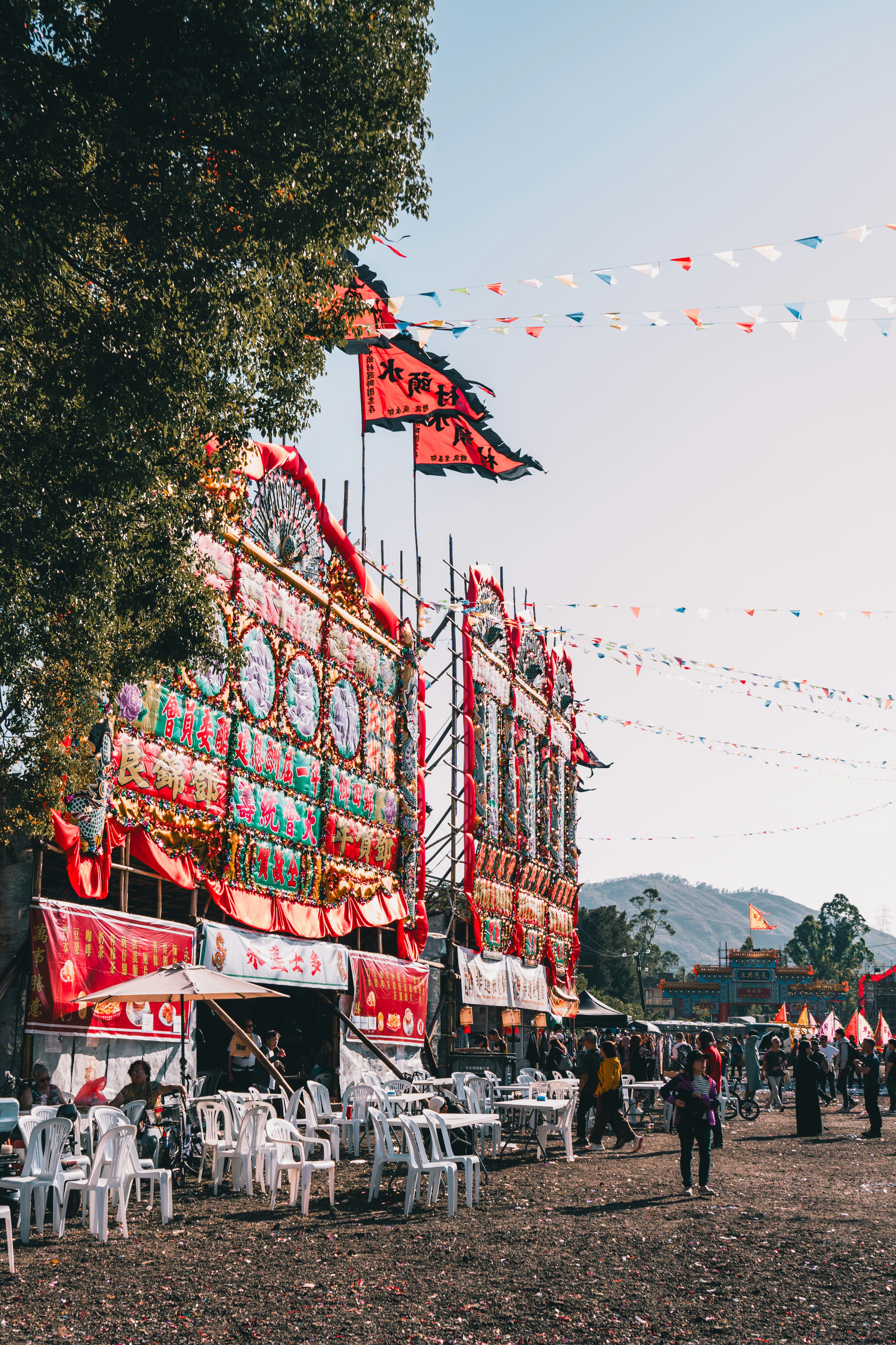 Festive Facades and Flags: A Market Scene Under Colorful Banners
