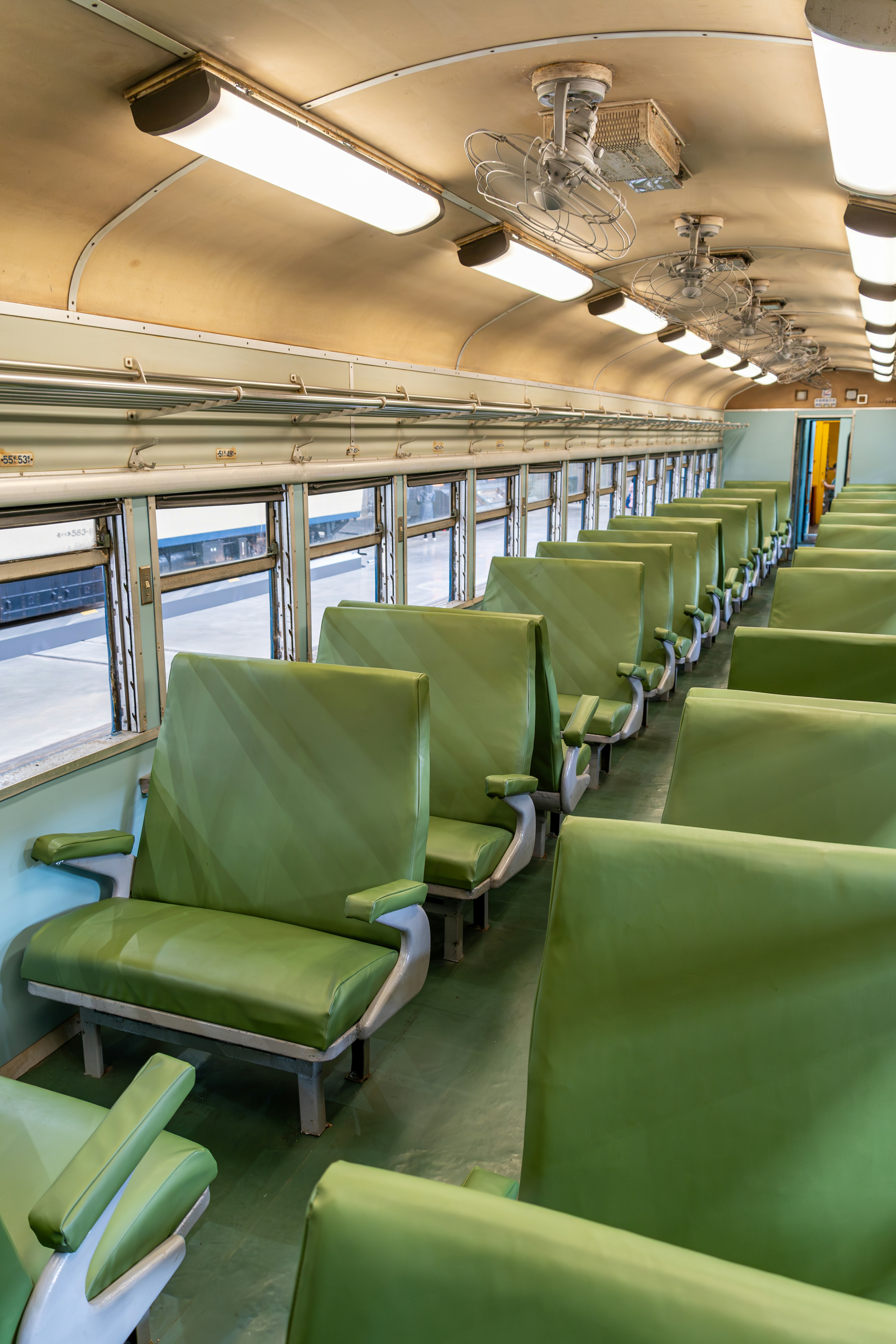 Aisle of Green: Abandoned-Commuter Silence in a Sunlit Rail Car