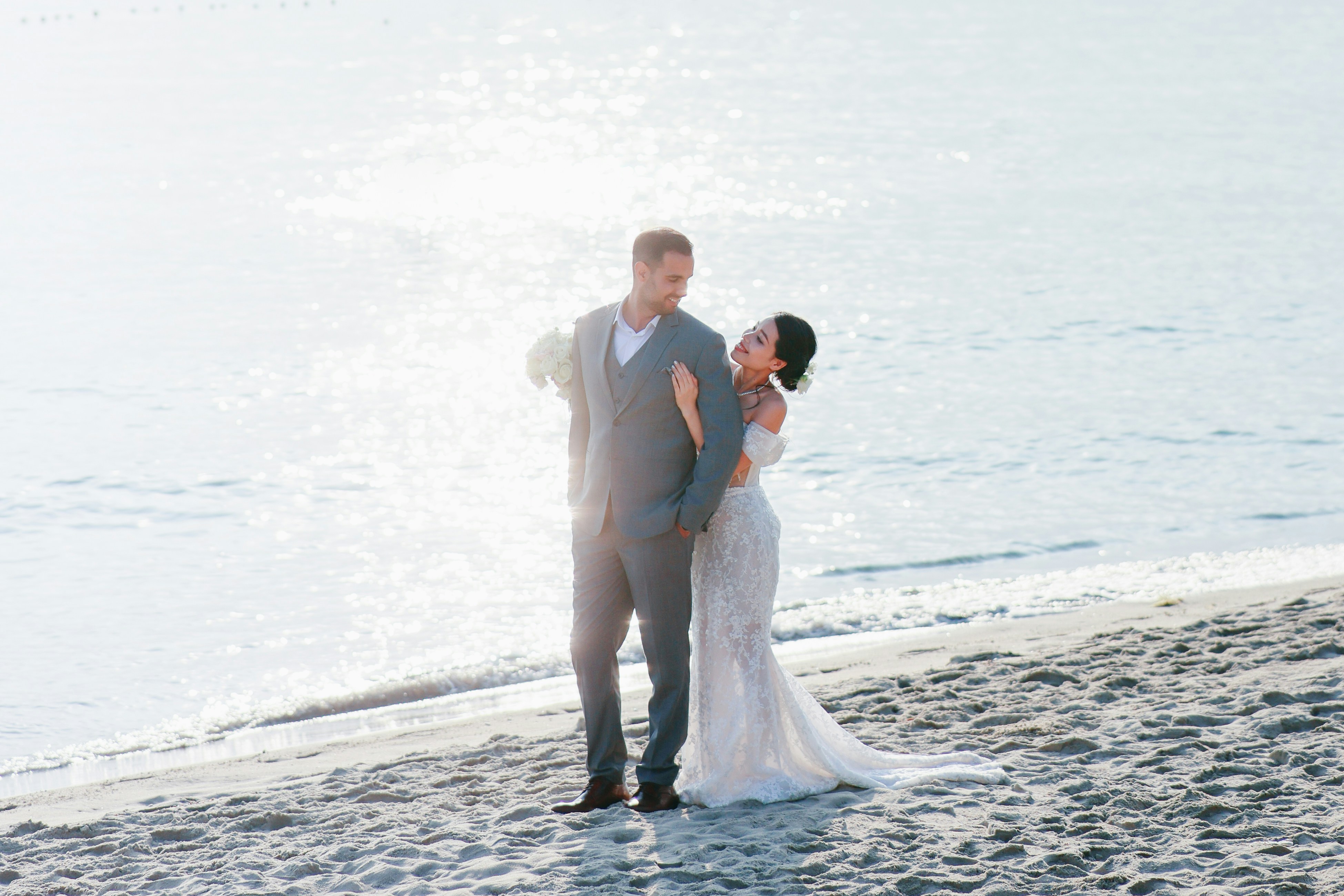 Wedding Couple By the Shoreline: A Quiet Embrace at Dusk