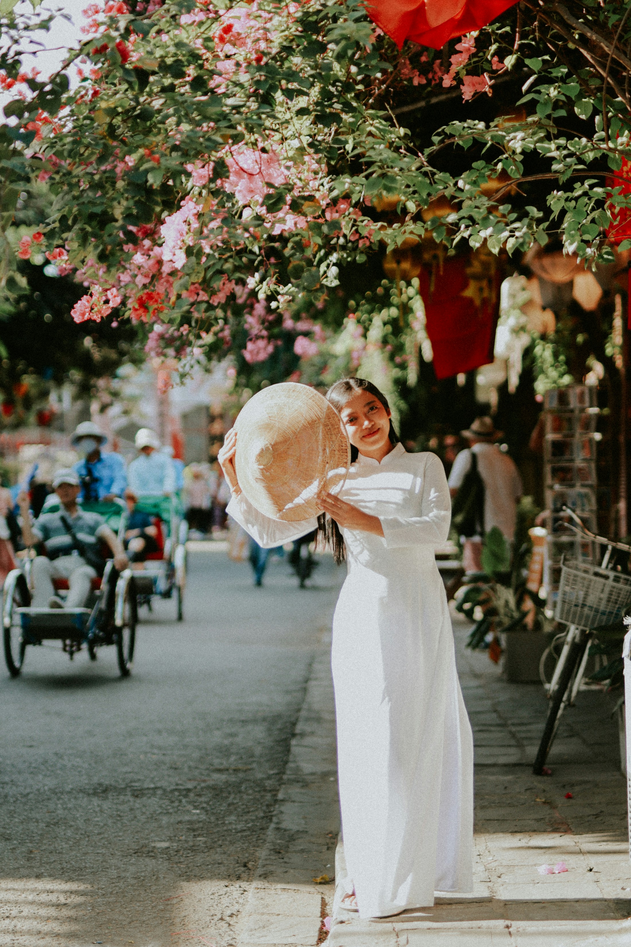 White Áo dài and a Straw Hat in Blooming Alley
