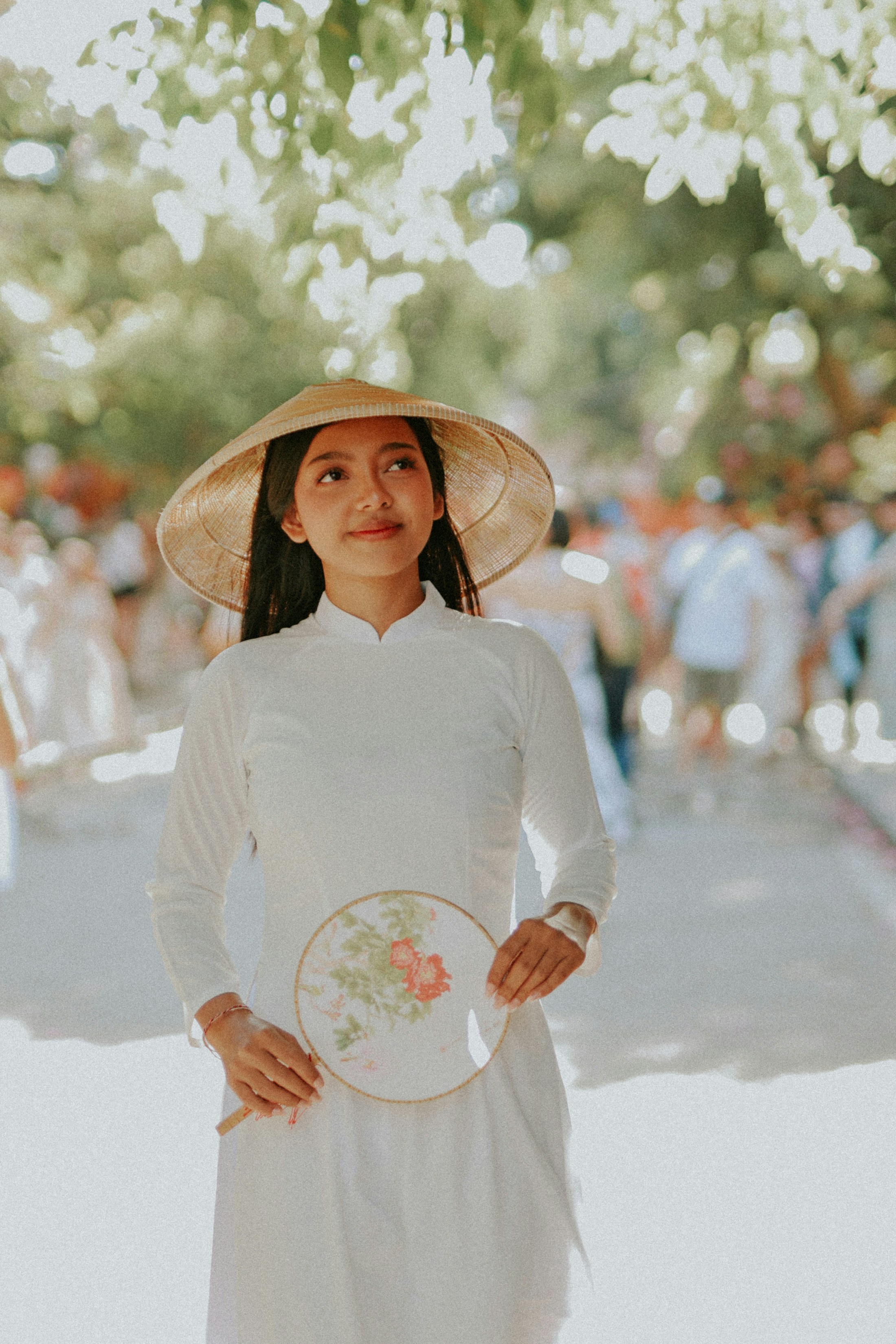 Portrait in White: A Calm Moment Beneath Dappled Light