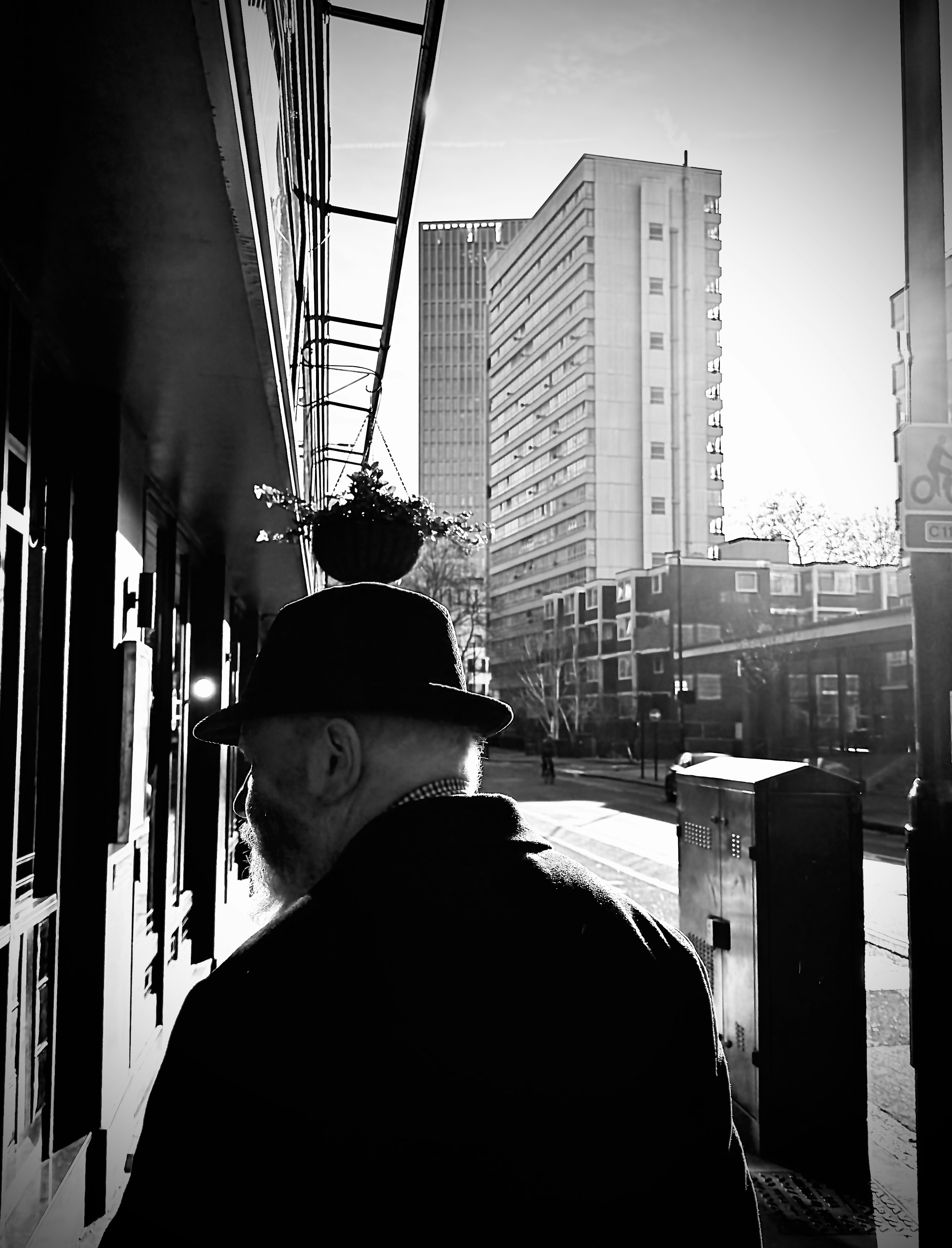 Shadowed Navigator Beneath Urban Light