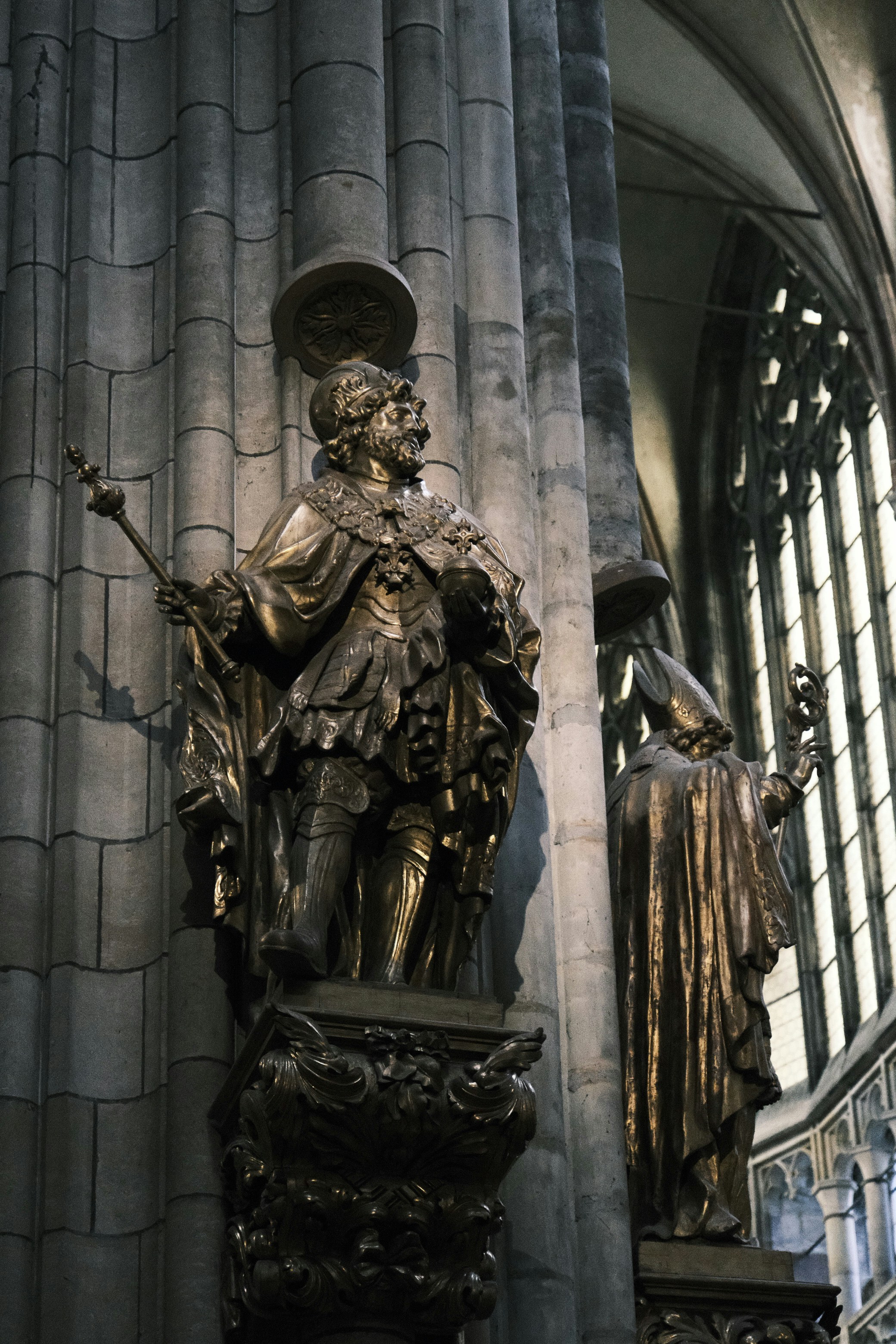 Bronze Saint at the Cathedral Altar: A Reverent Gaze toward the Light