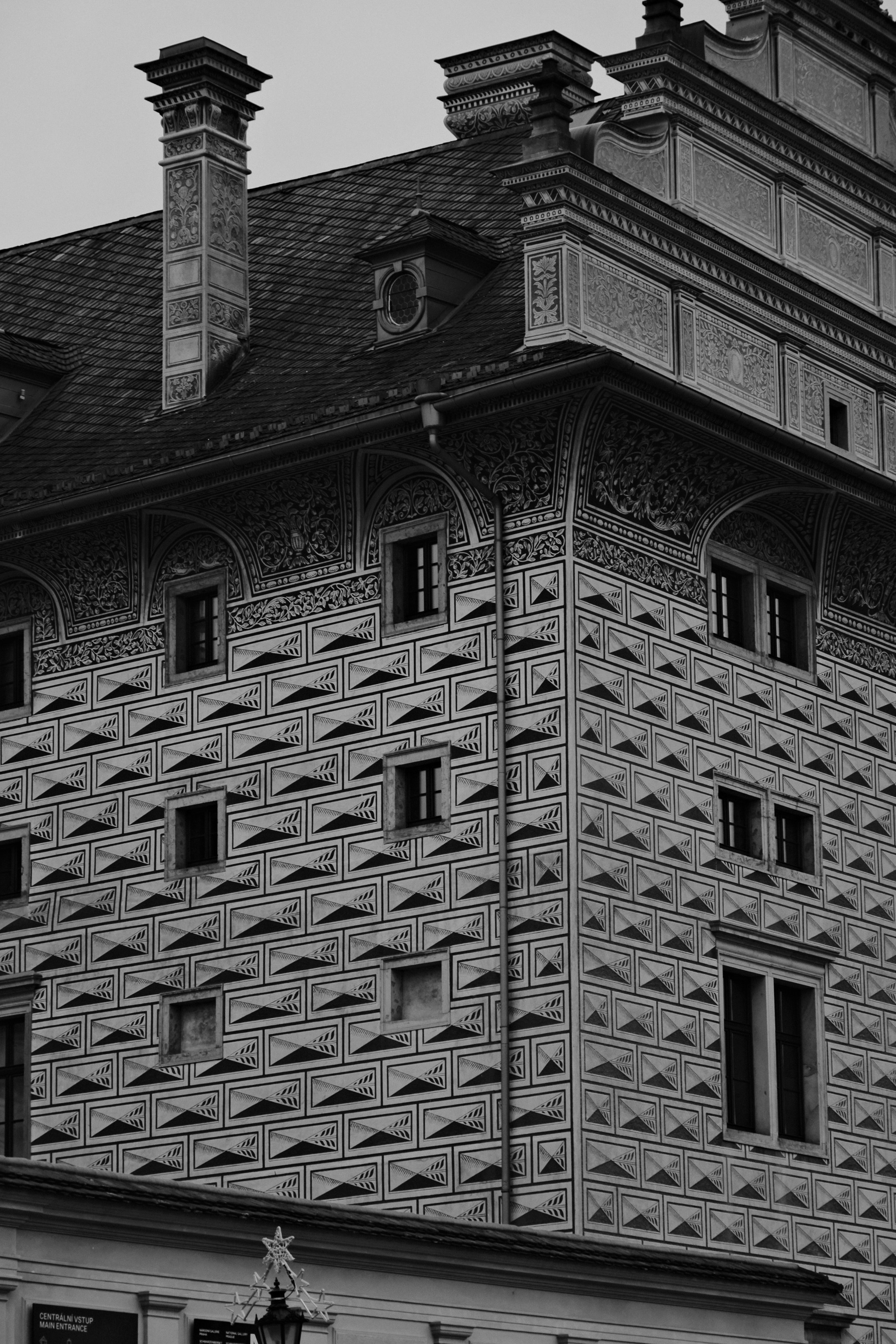 Intricate Facade: A Faceted Pattern of Tiles and Gothic Detailing