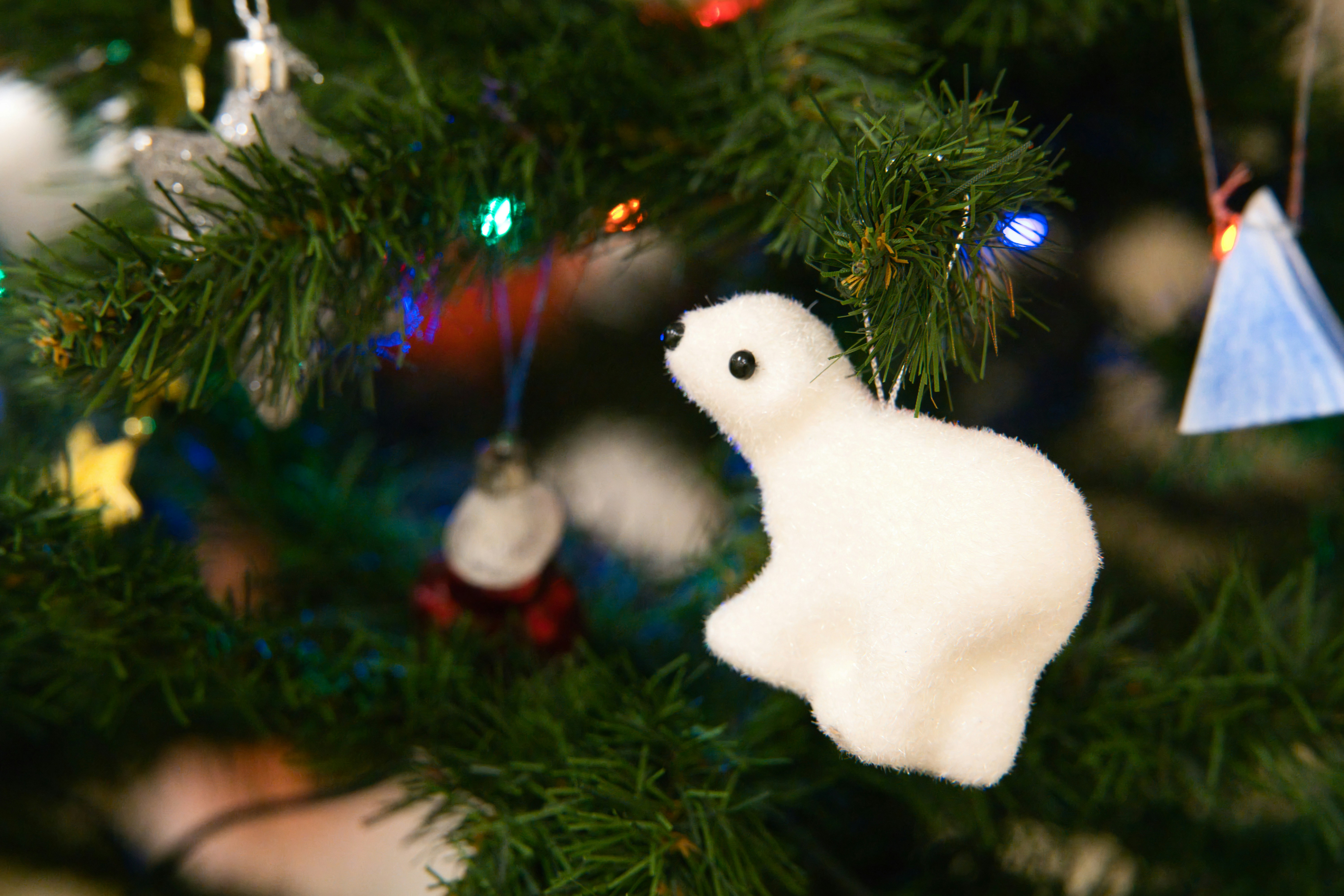 White Polar Bear Ornament Hanging on a Gleeful Christmas Tree