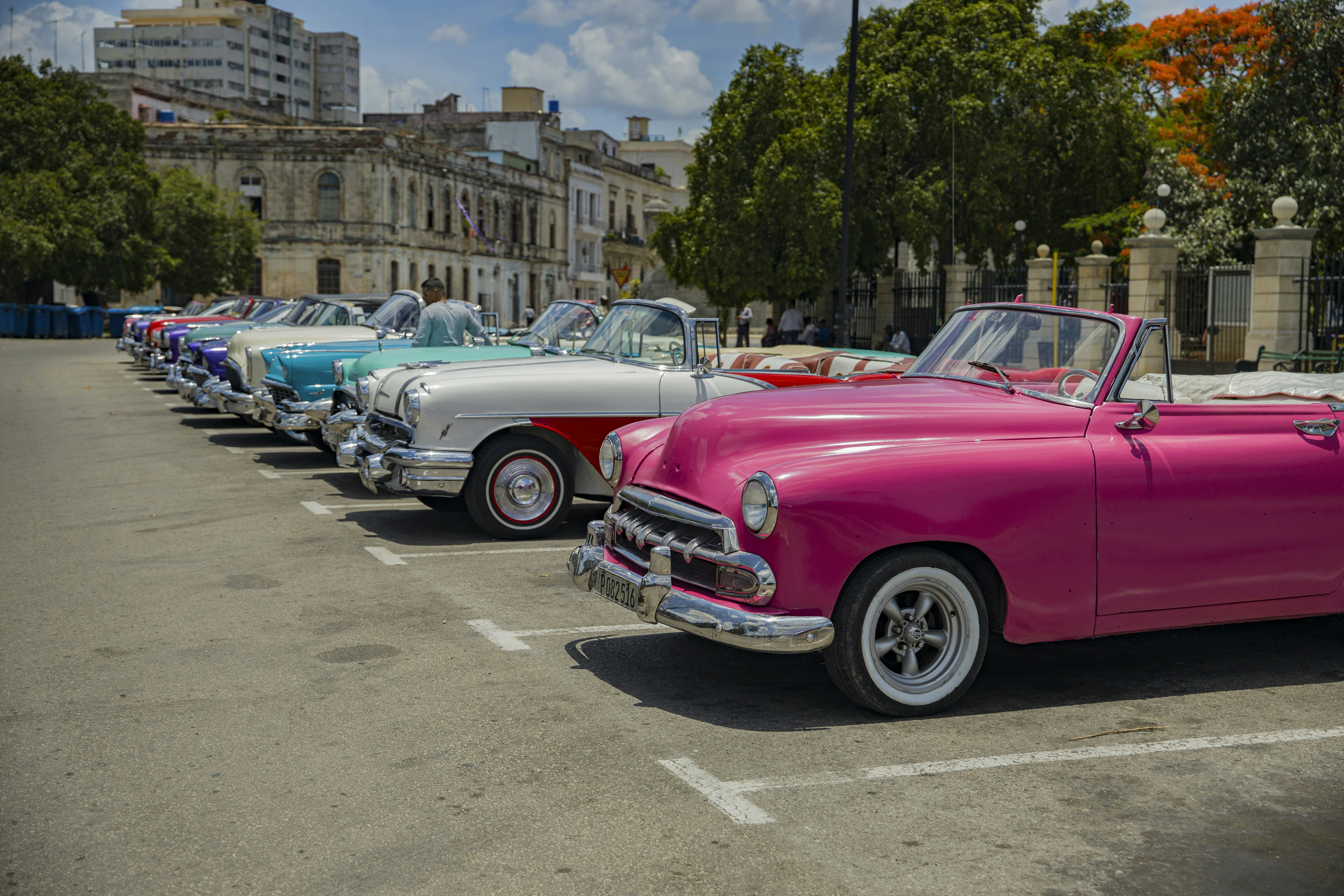 Candy-Colored Classic: A Row of Vintage Convertibles Reigniting a Havana of Chrome