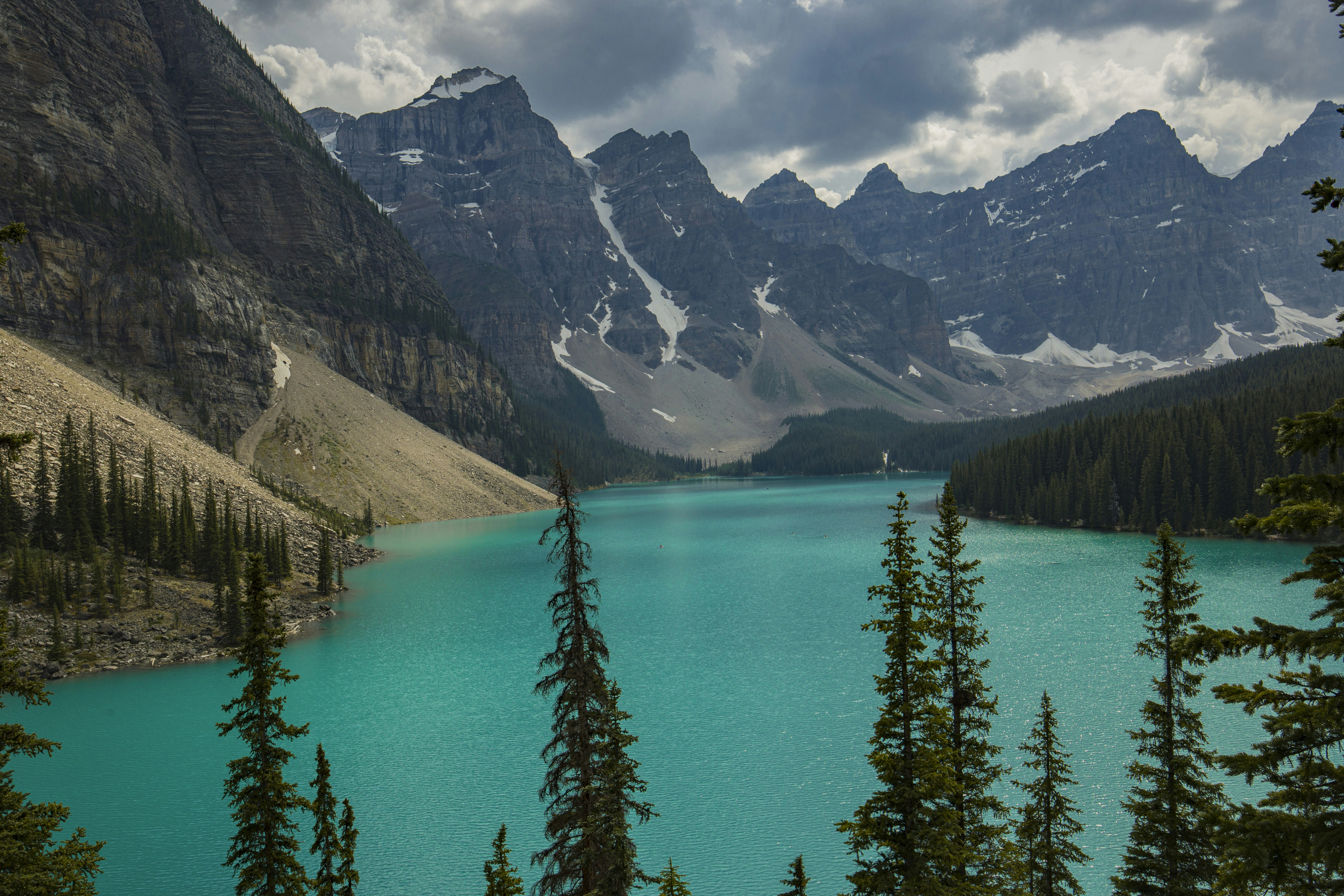 Azure Mirror: Turquoise Lake Surrounded by Rugged Peaks