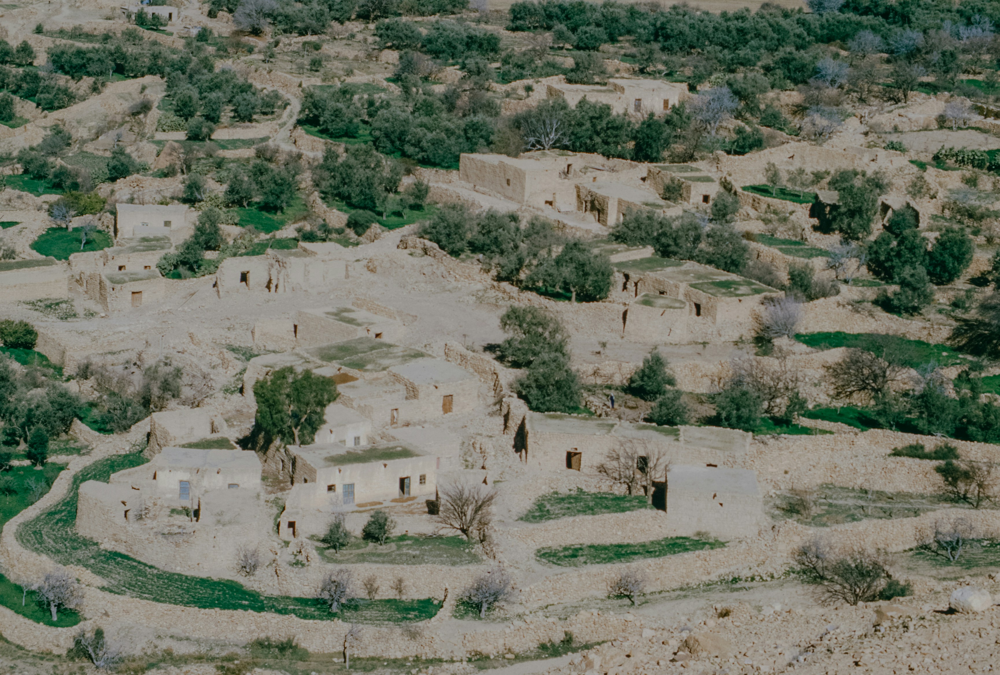 Ancient village ruins nestled in a dry, rocky landscape.