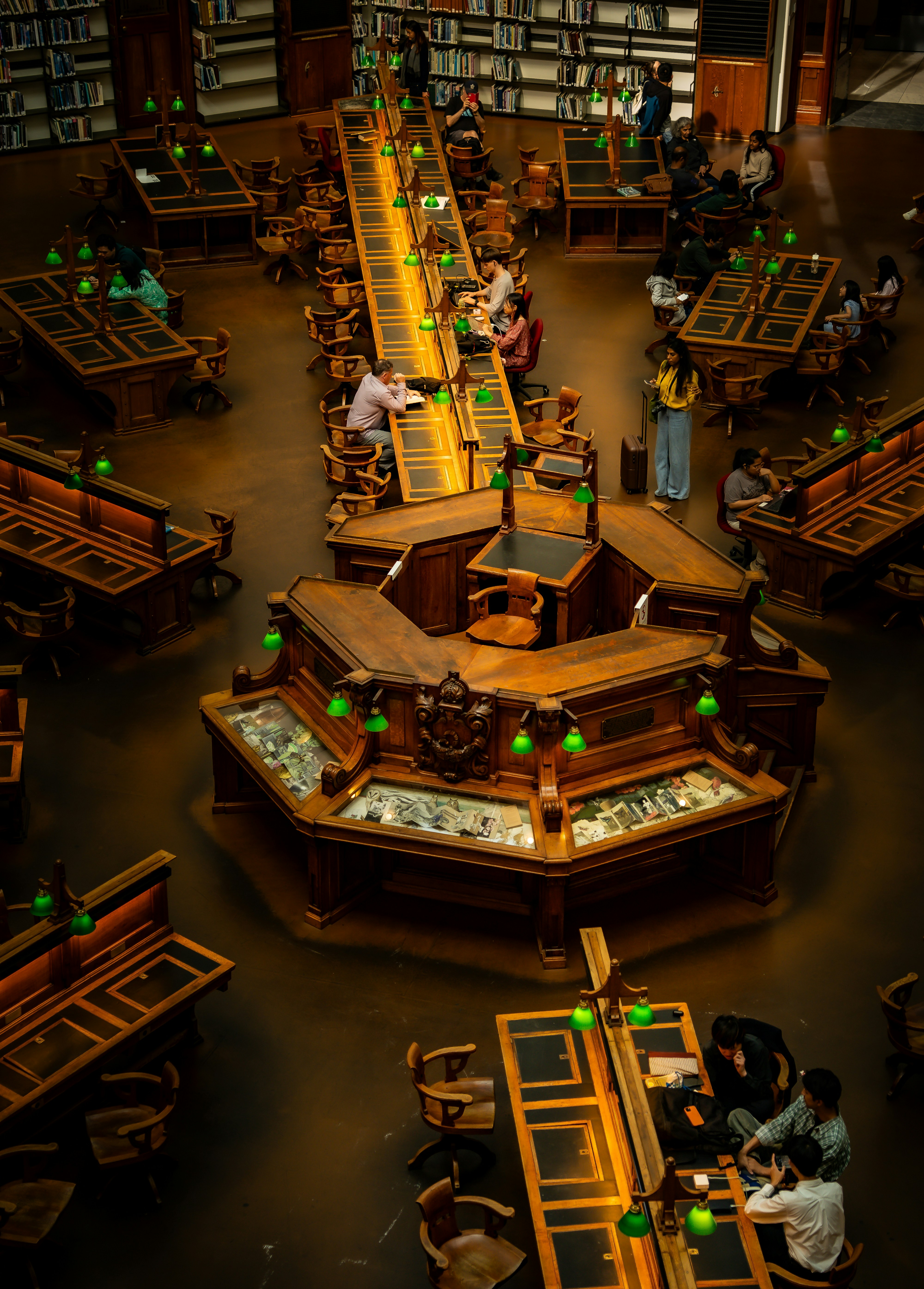 People studying at long wooden tables in library photo – Free ...