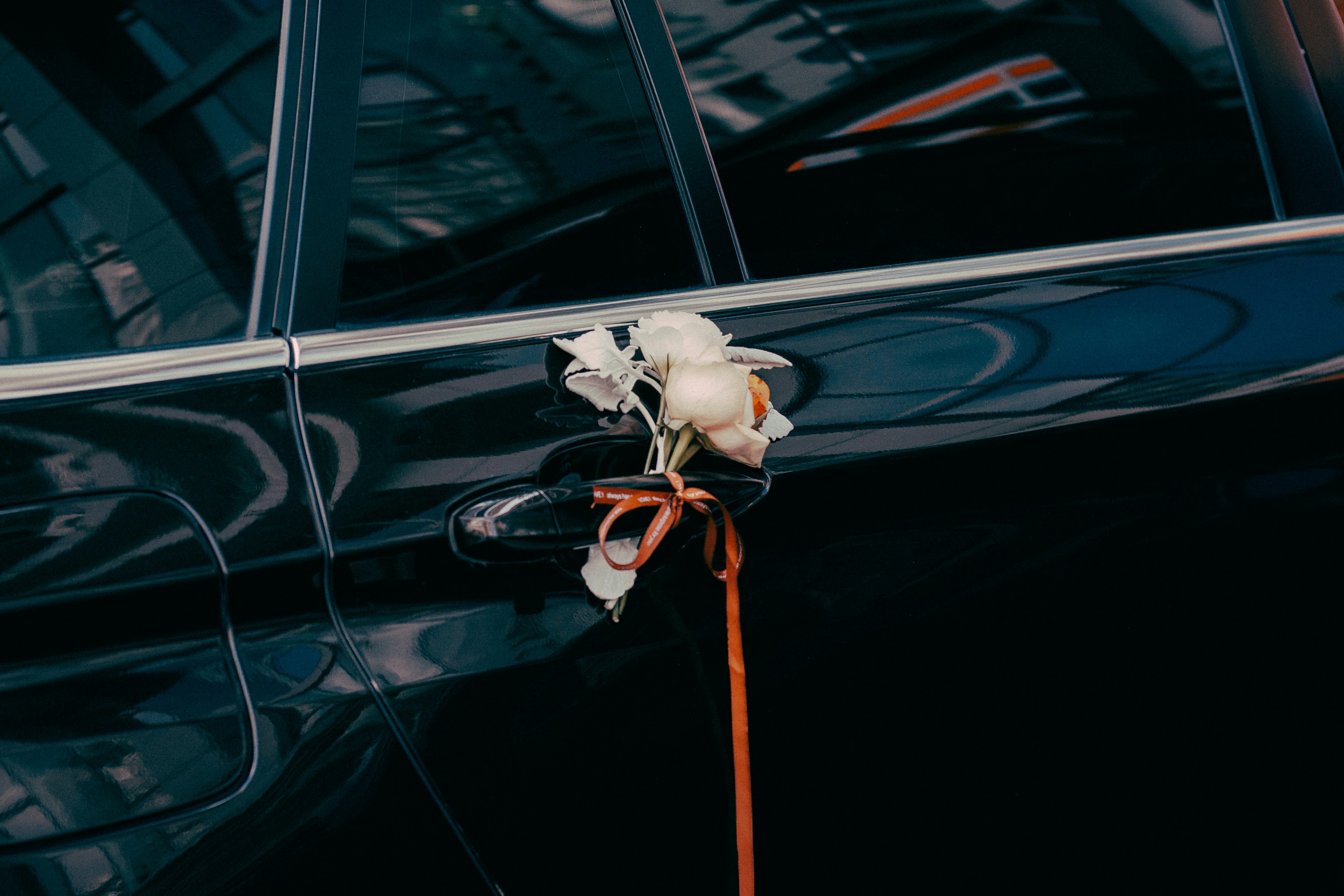 Floral Tie on a Midnight Car: A Quiet Wedding Detail