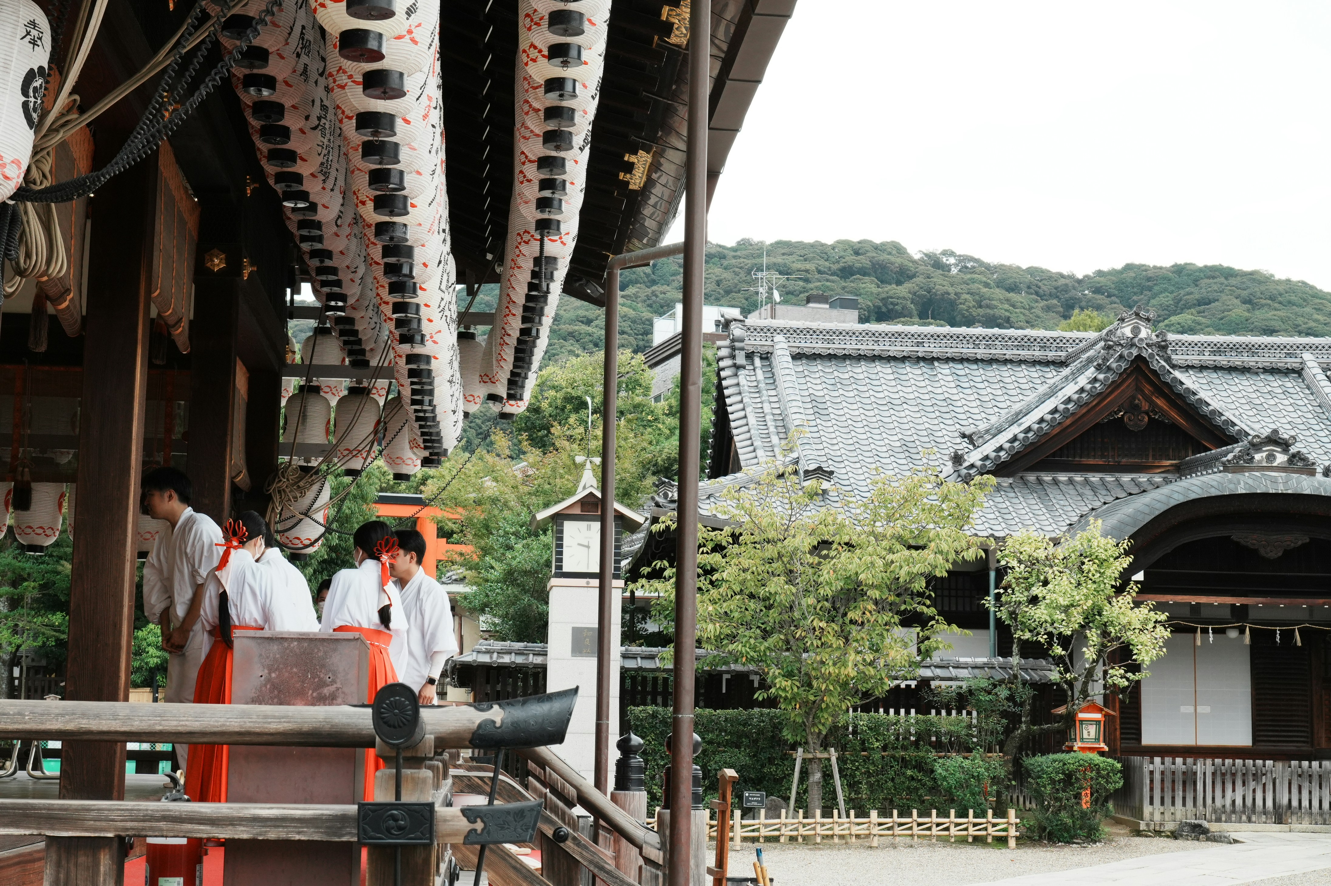 Quiet Temple Courtyard: Monks in Orange Robes at the Gate