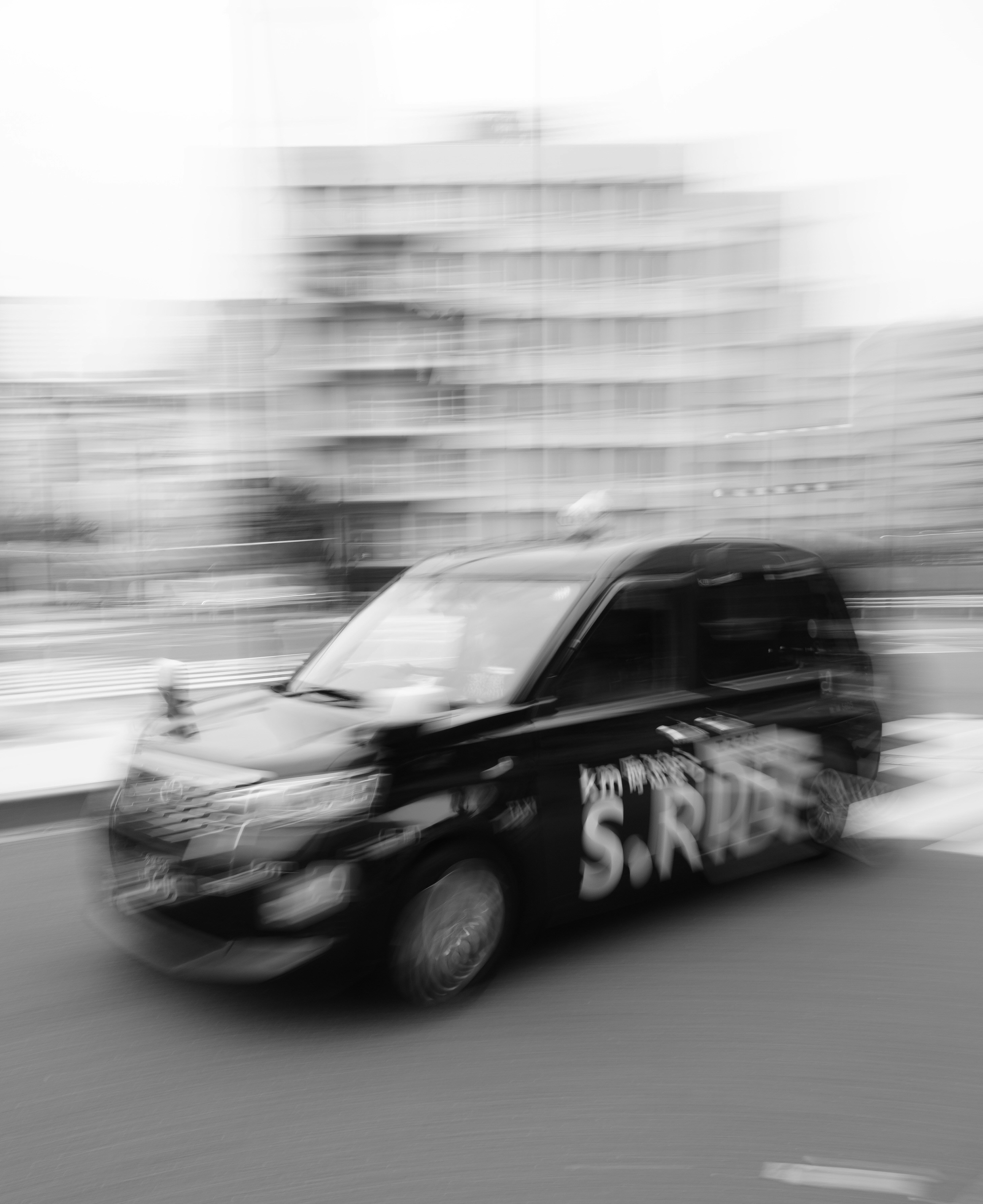 Motion in Black: A Blur of a City Van in Transit