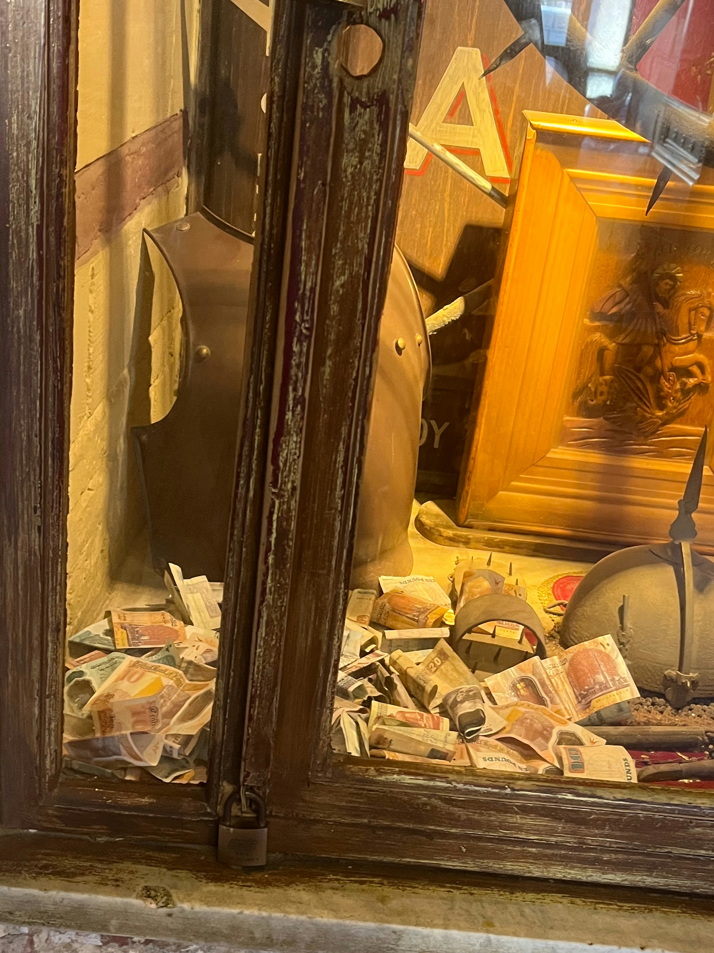 Treasure of the Window Display: Coins, Helm, and Frames in a Dim Window
