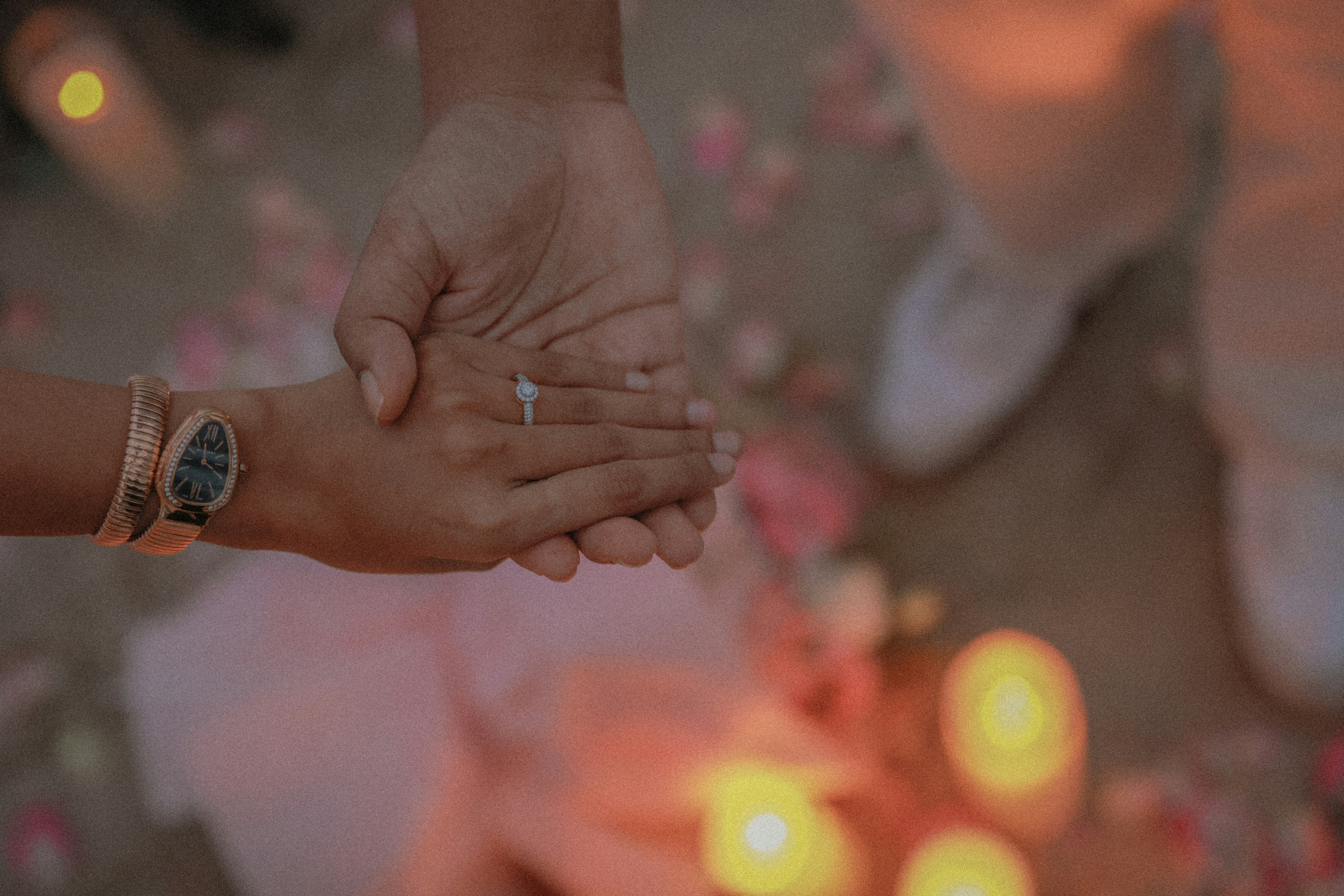 A tender handoff: a delicate ring shared at dusk