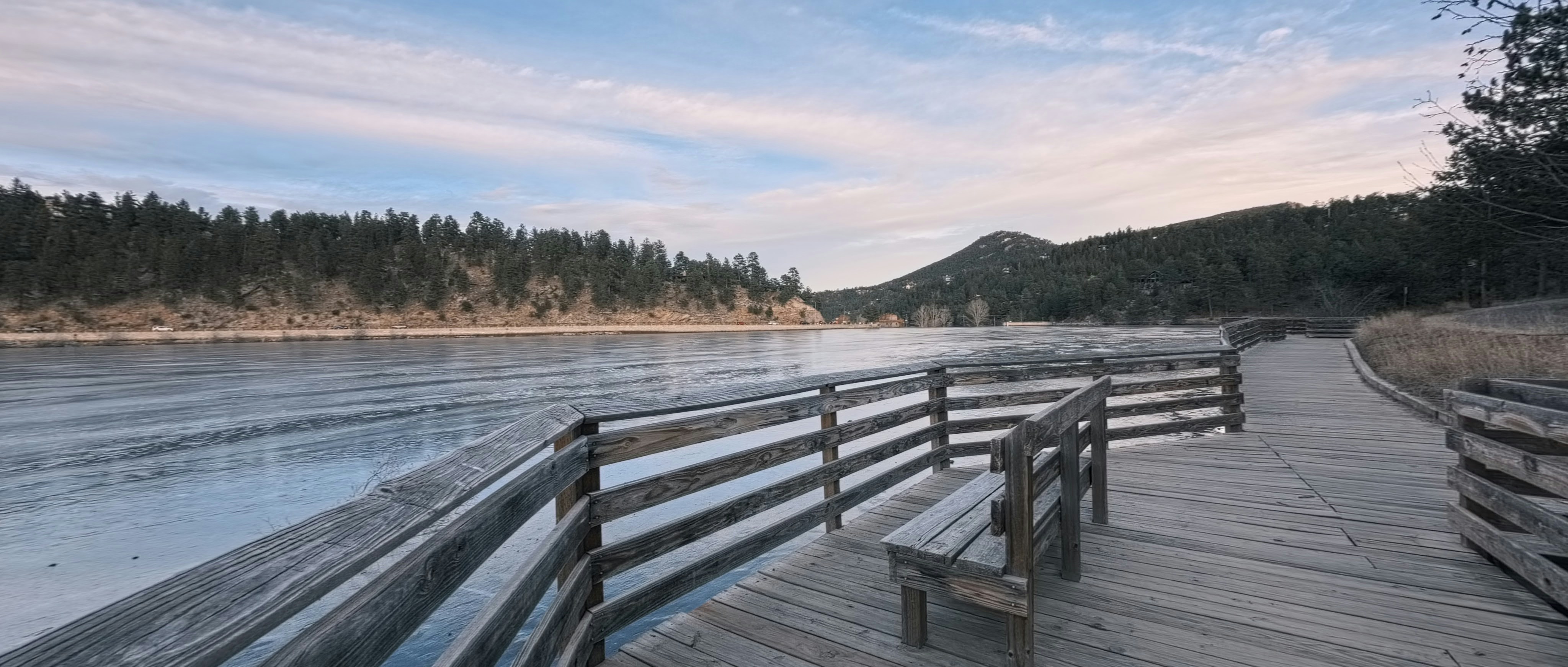 Sunlit Boardwalk Over Reflective Lake, Framing a Tranquil Path