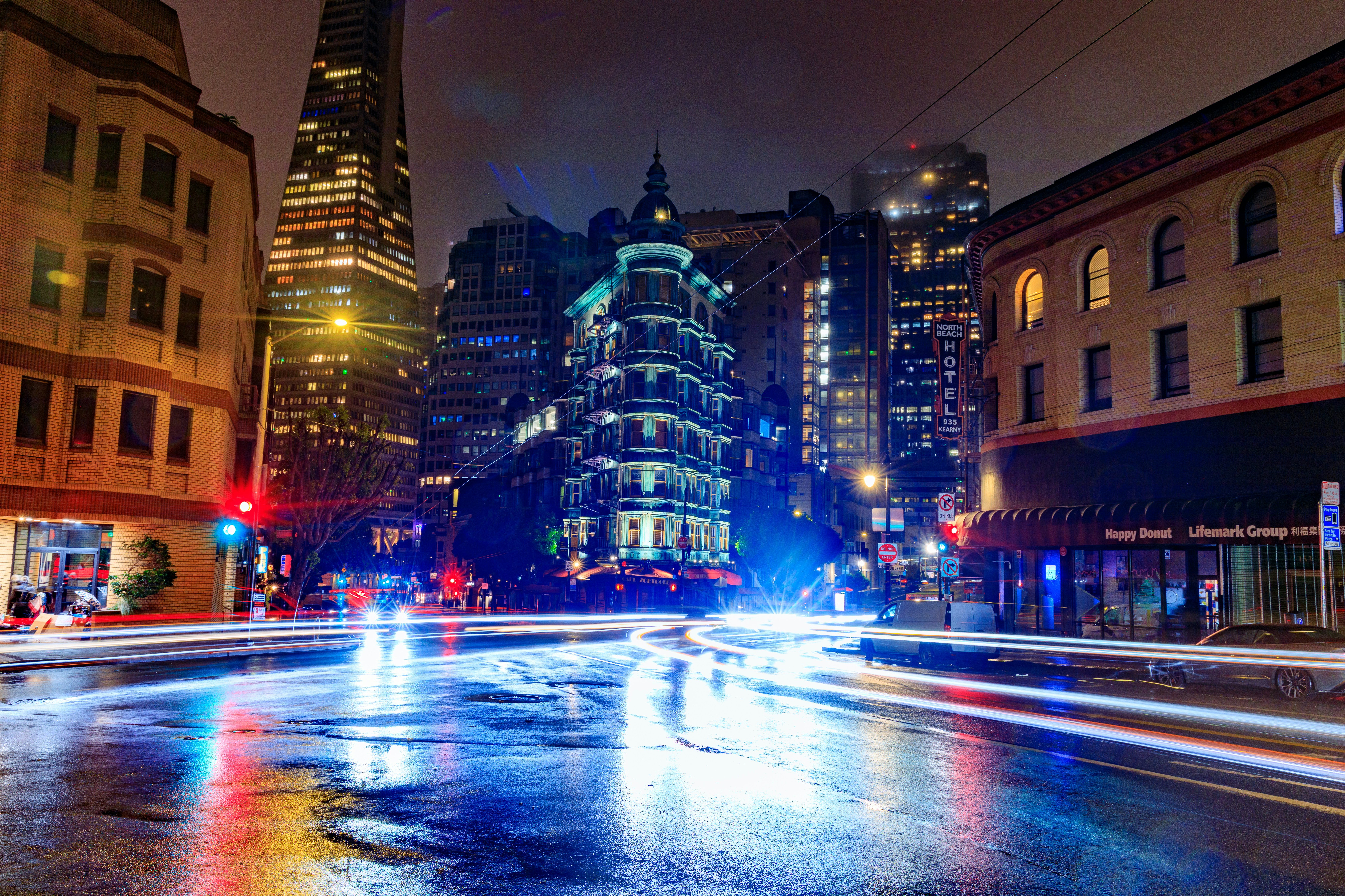 Nighttime Vista: Neon Arcs Over a Rain-Slick Downtown