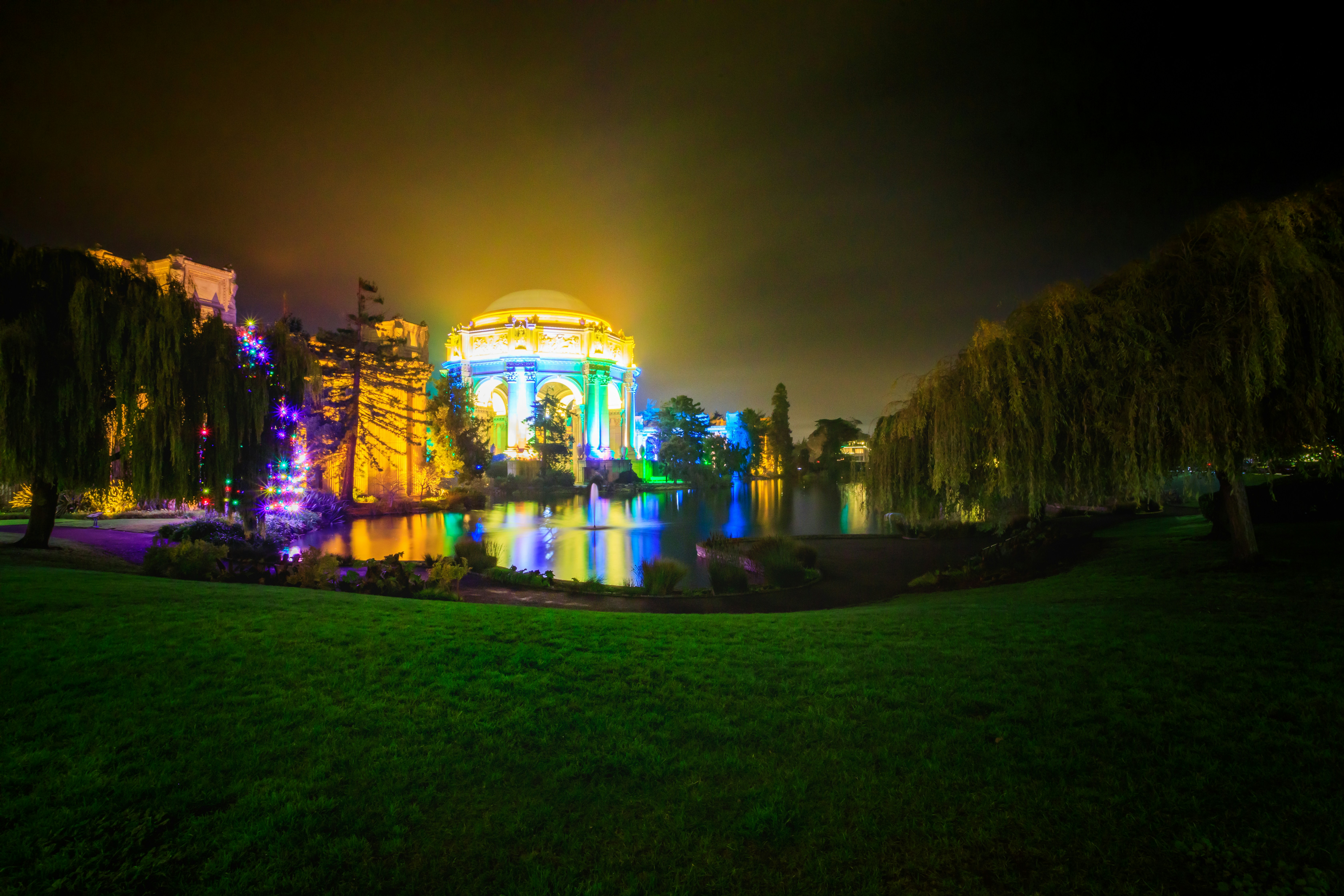Illuminated rotunda by night: a glow of reflection over still water