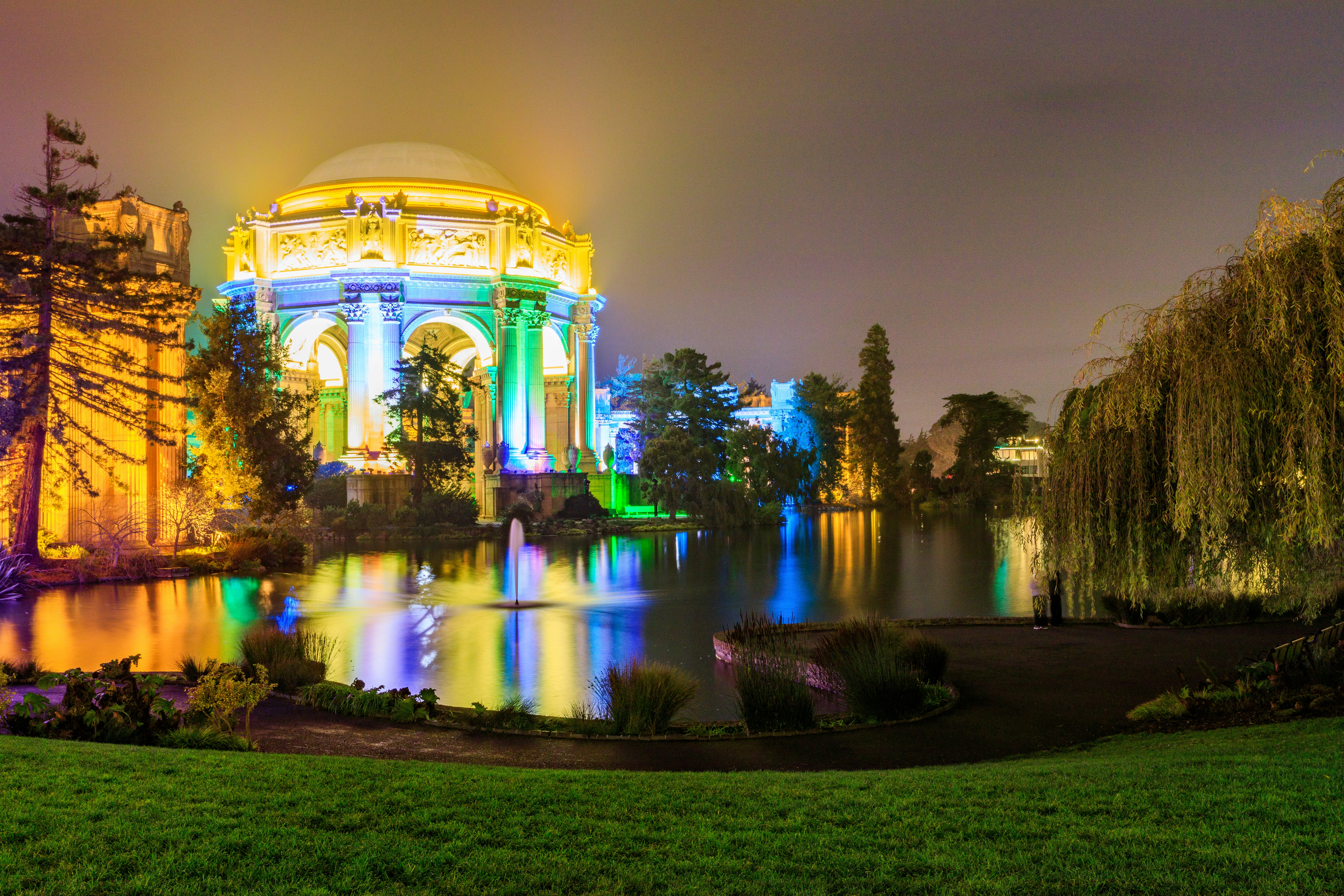 Luminous Pavilion: Night-time Colors Reflected in a Serene Park Lake