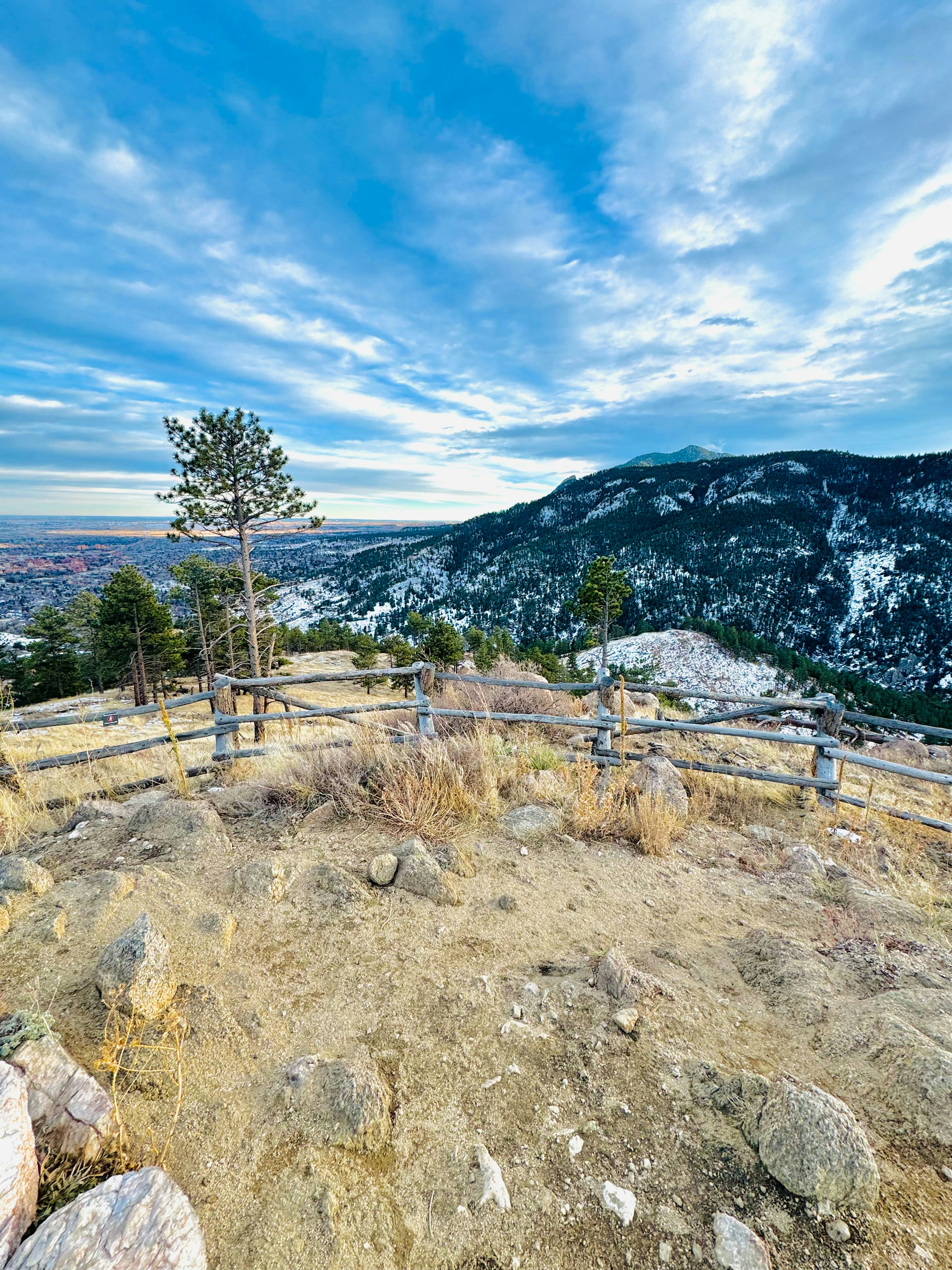 Overlook on Weathered Pines: A Rocky Trail Between Fences and Snow